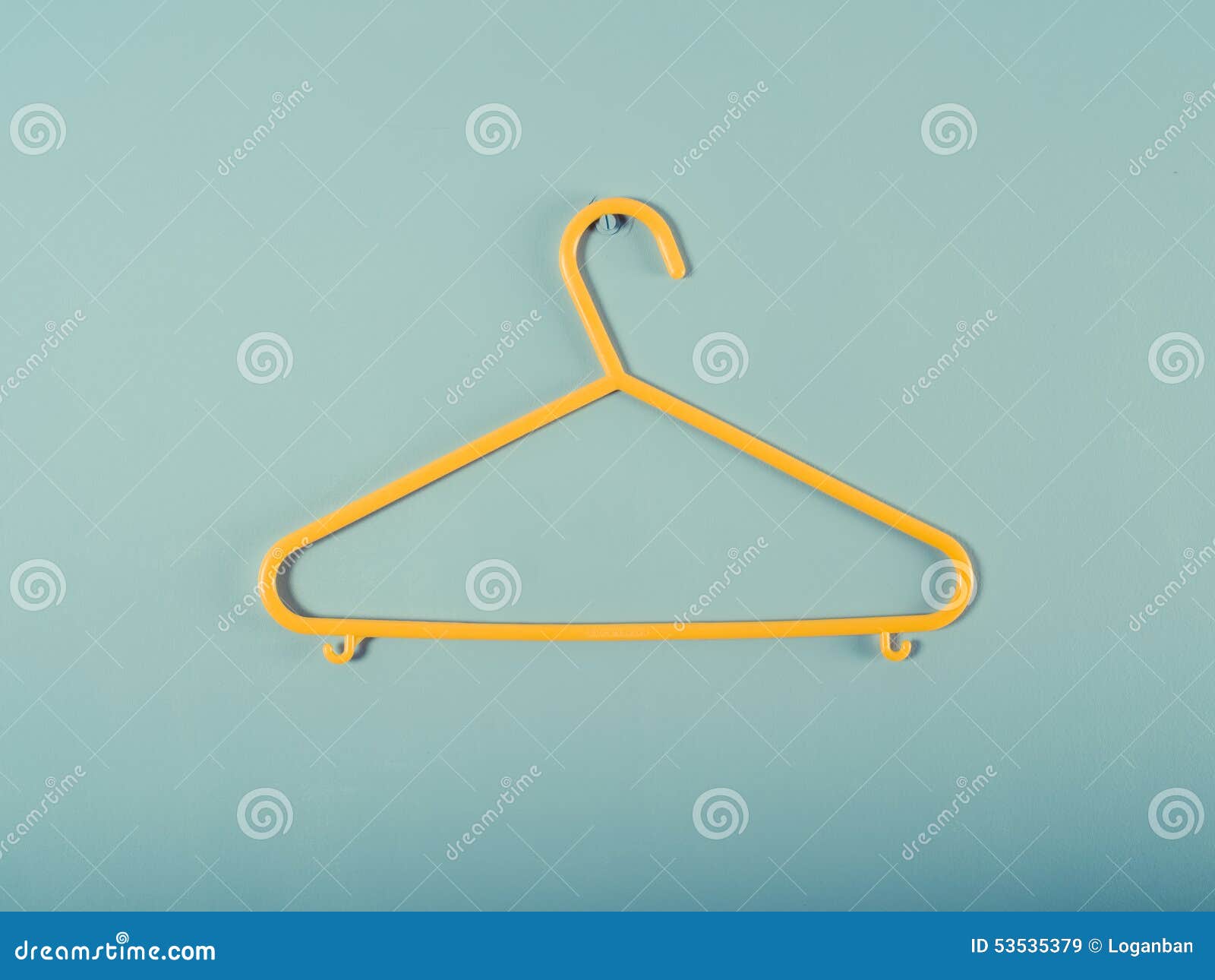 Yellow Plastic Hanger on a Blue Wall Stock Image - Image of room ...