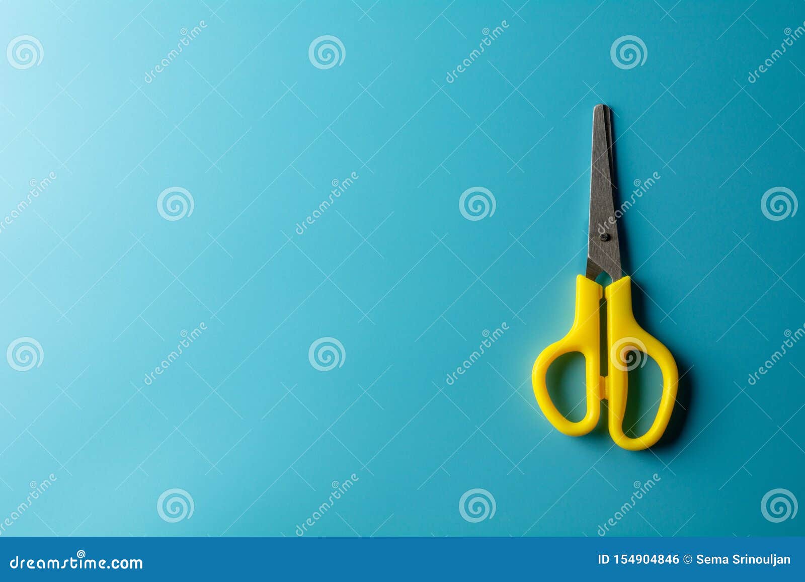 Yellow Plastic Scissors on Blue Paper. - Background Stock Photo - Image ...