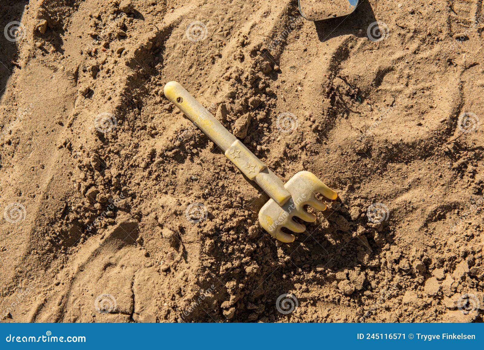 Yellow Plastic Toy Rake in the Sand at a Playground.. Stock Image ...