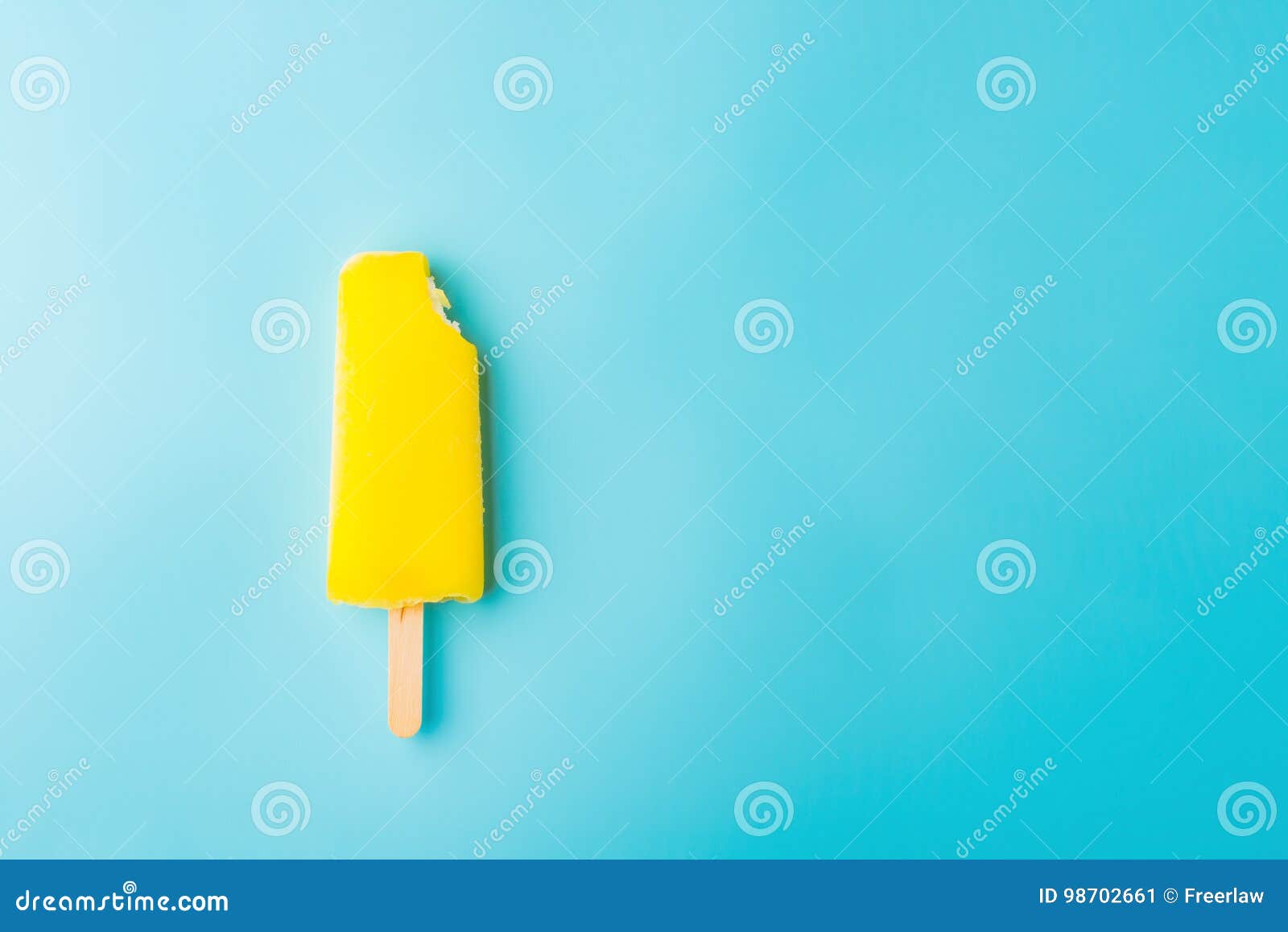 Yellow Popsicle with a Bite on Blue Stock Image - Image of cool, frosty ...
