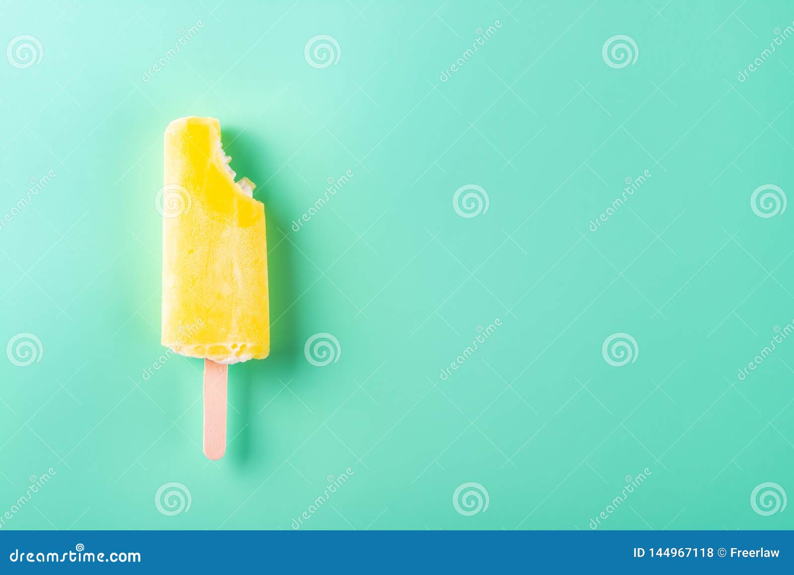 Yellow Popsicle with Bite on a Light Blue Background Stock Photo ...