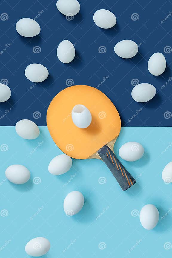 The Yellow Racket is in the Middle of the Table. There is a Split Egg ...