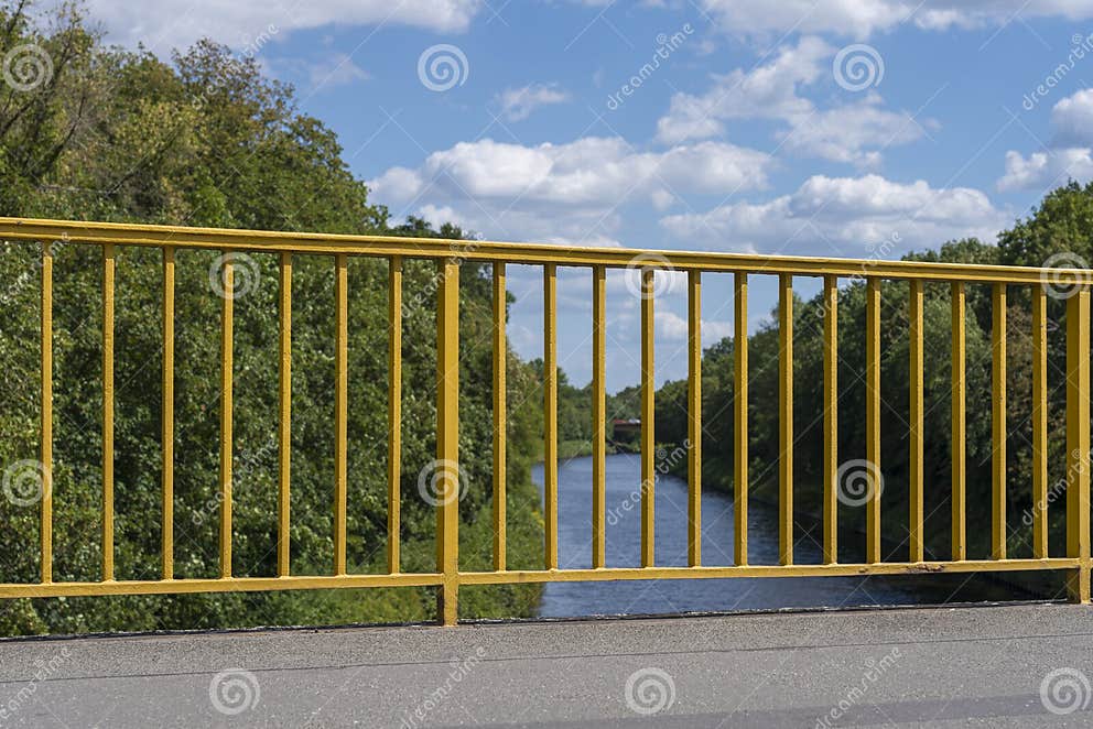 Yellow railing on a bridge stock image. Image of railing - 157781581