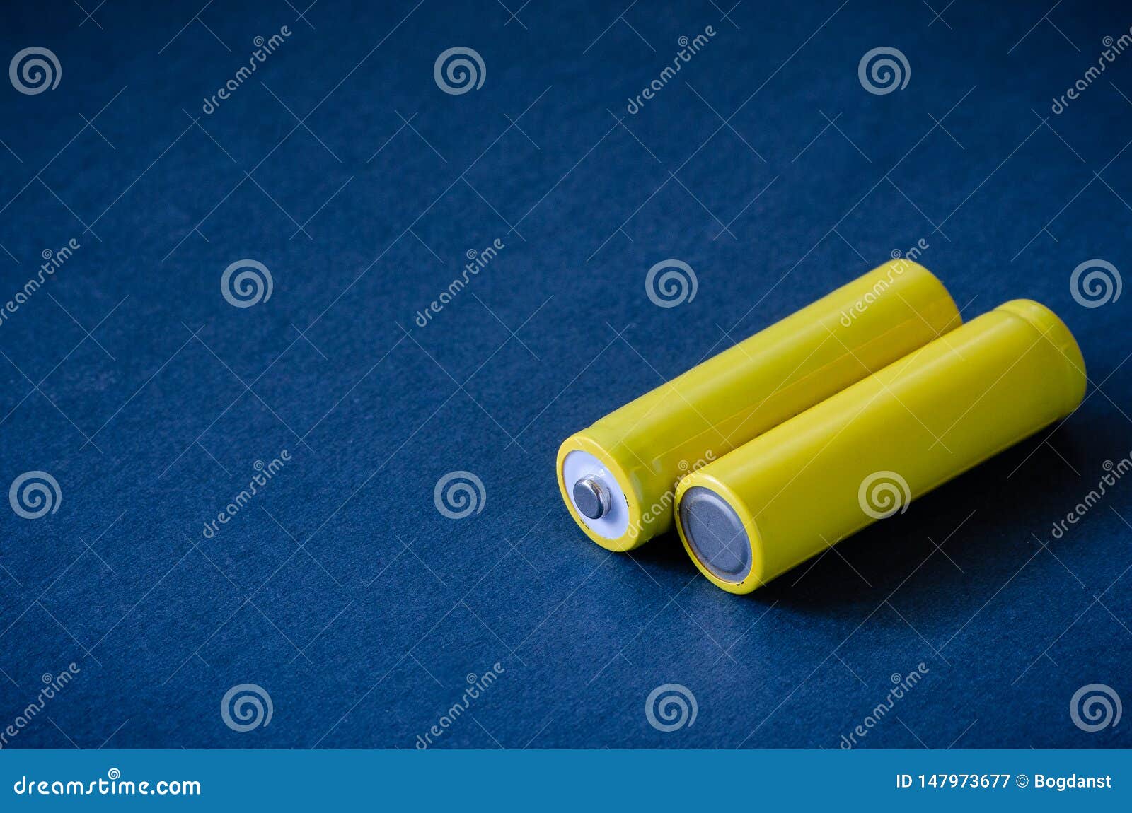 Yellow Rechargeable Batteries on Blue Background Stock Image - Image of ...