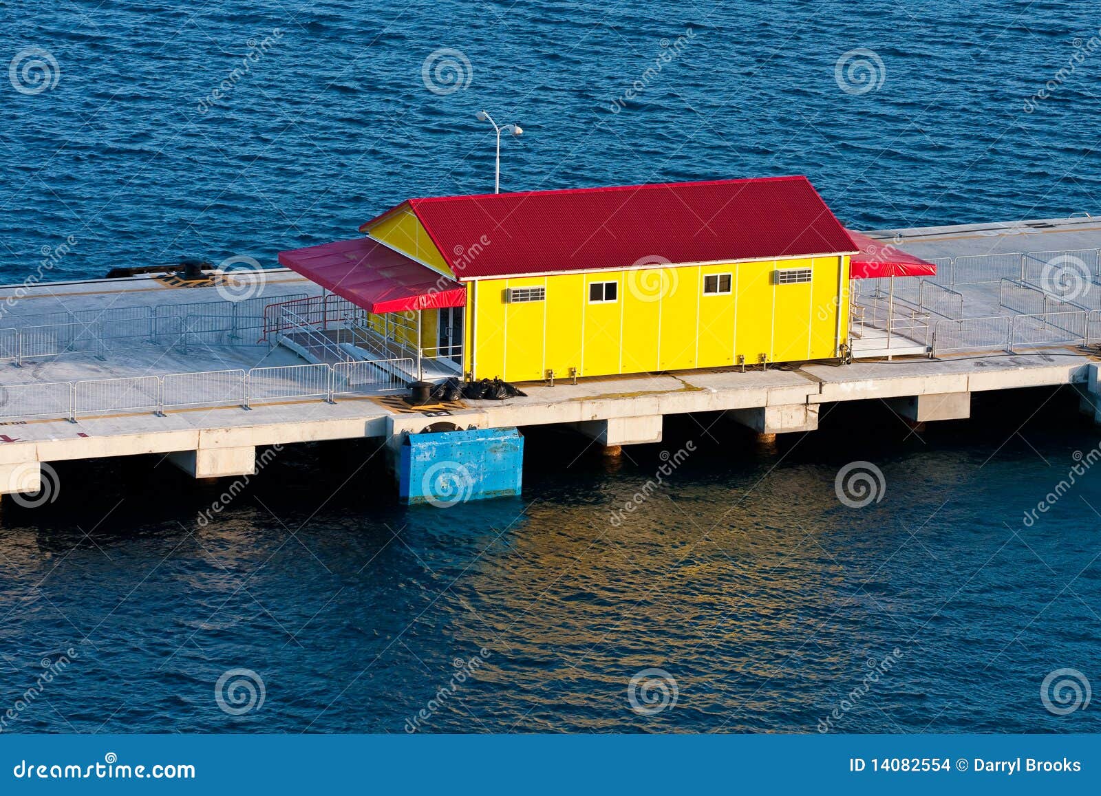 Yellow and Red Building on Pier Over Blue Water Stock Photo - Image of ...