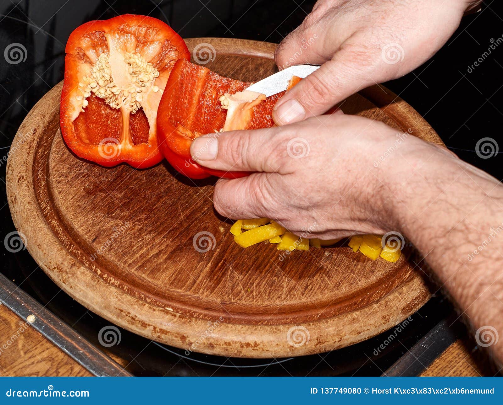 Yellow and Red Peppers Capsicum Cut with a Knife on a Board Stock Photo ...