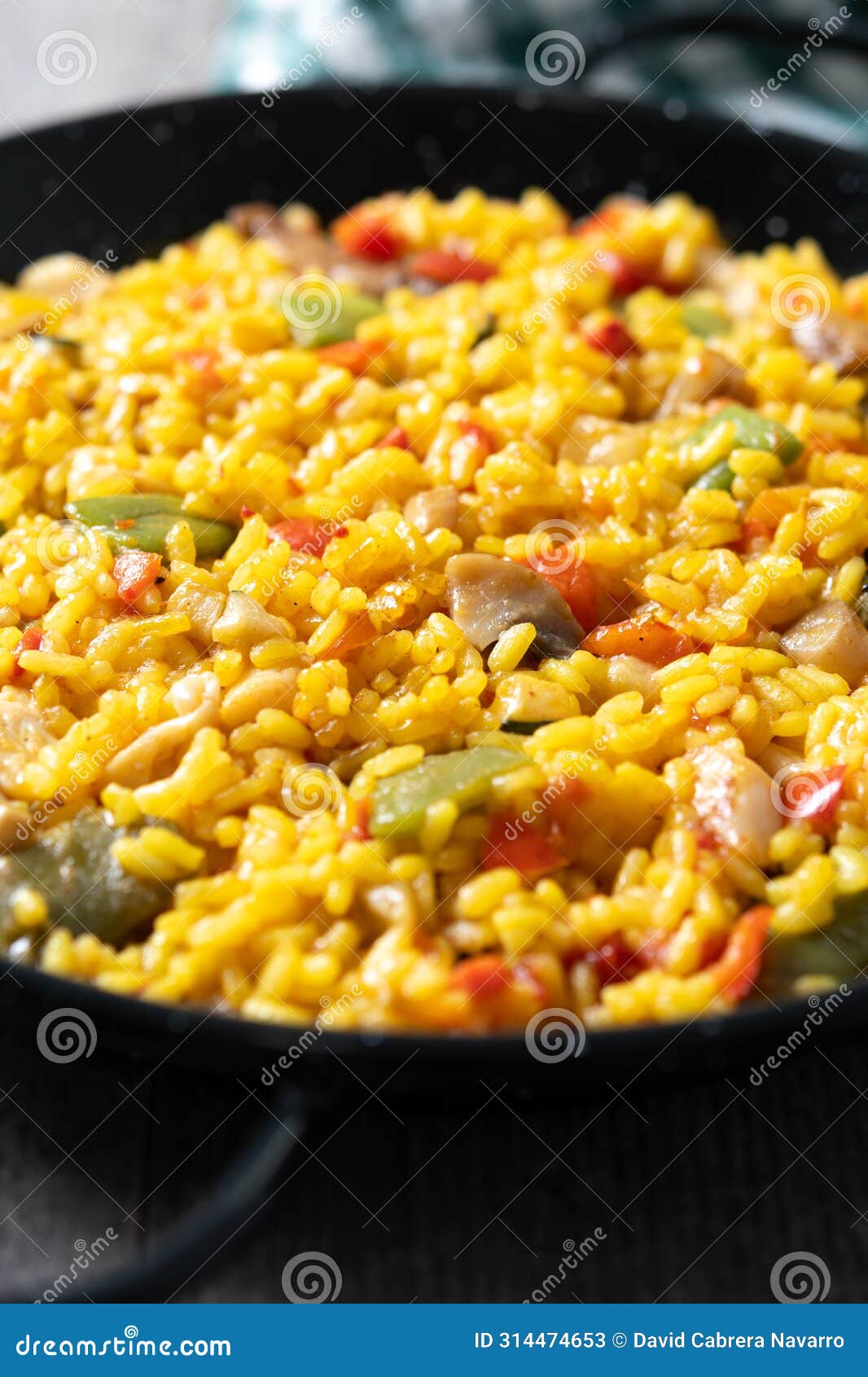 Yellow Rice with Chicken and Vegetables on Wooden Table Stock Image ...