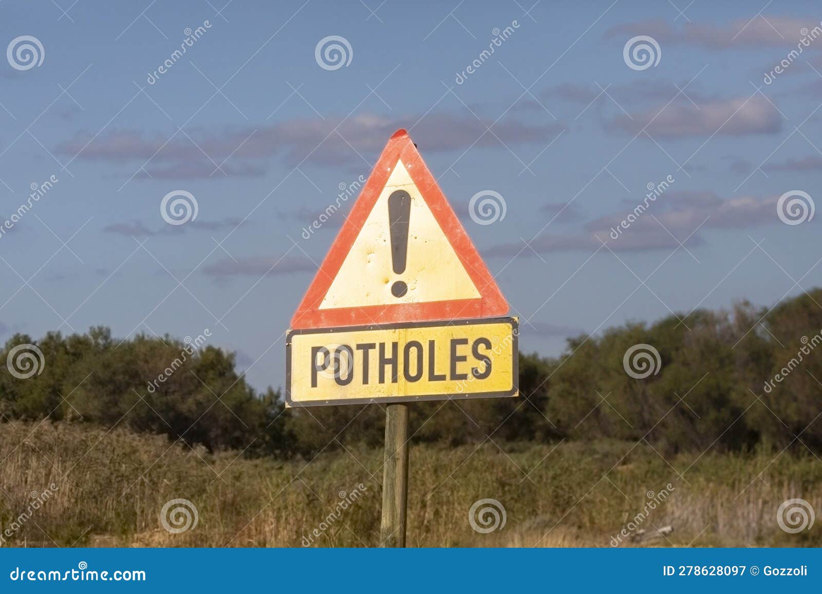 Yellow Road Traffic Warning Sign for Potholes at the Side of a Rural ...