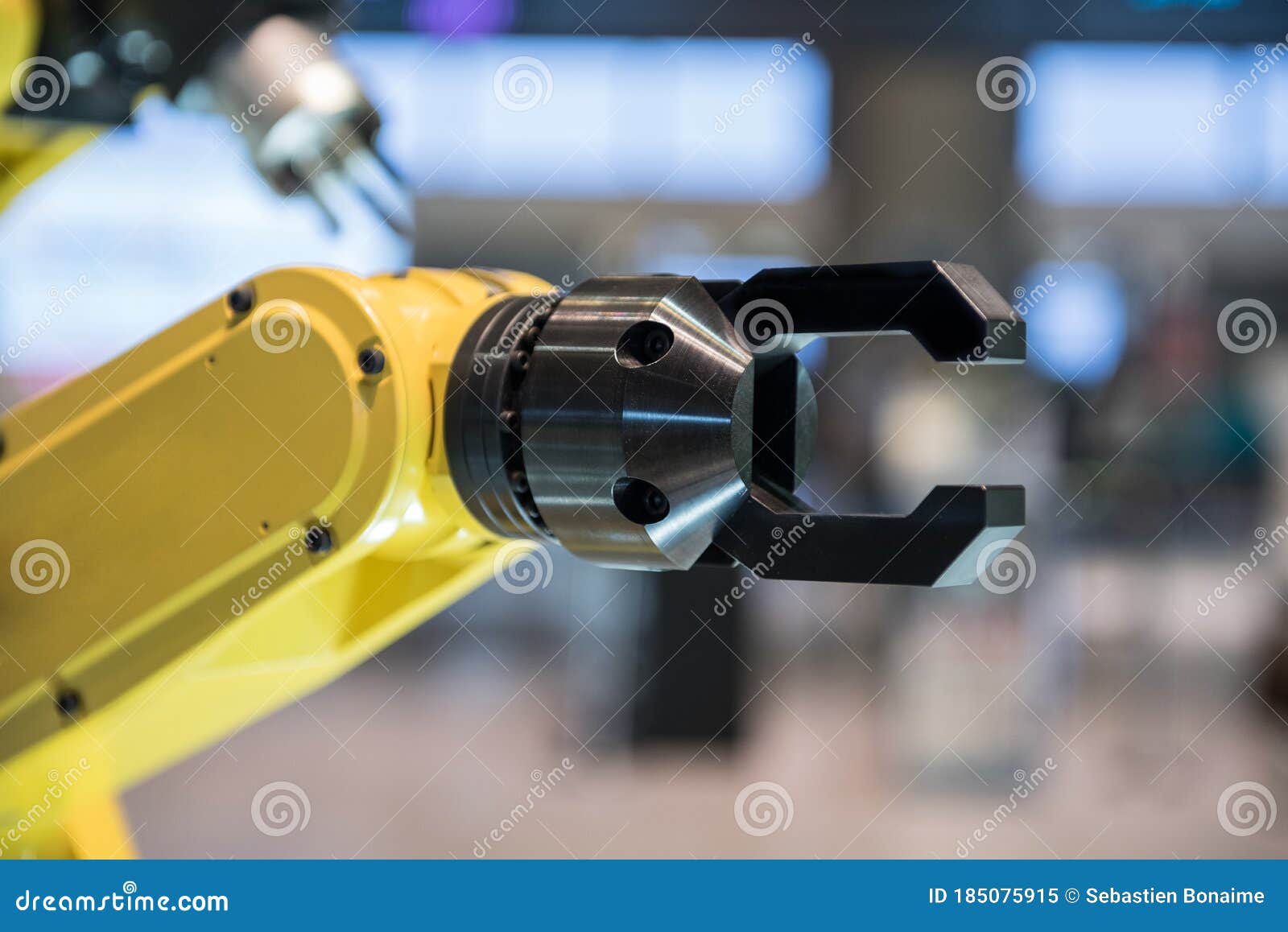 A yellow robotic arm stock image. Image of industry - 185075915