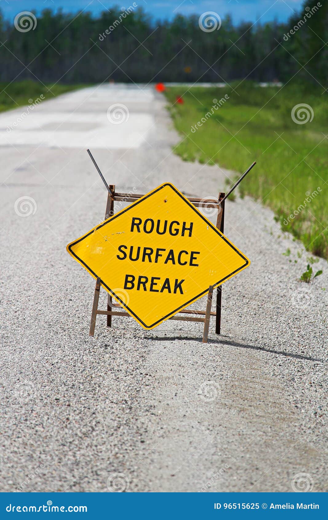 A Yellow Rough Surface Break Sign with a Road Blurring into the ...