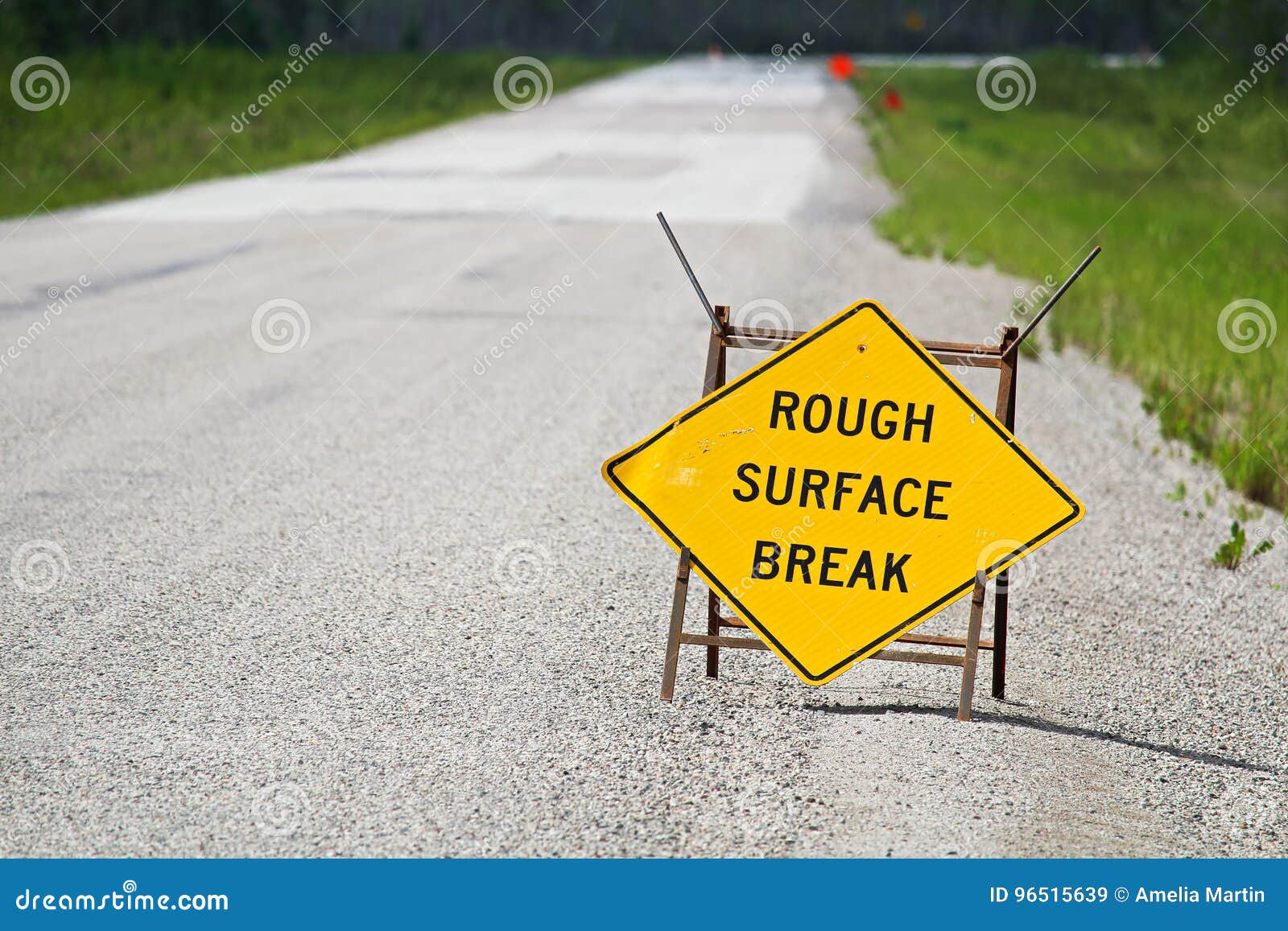 A Yellow Rough Surface Break Sign with a Road Blurring into the ...