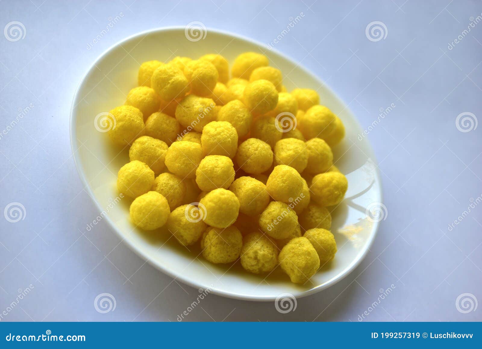 Yellow Round Corn Snacks on a White Plate Stock Image - Image of ...
