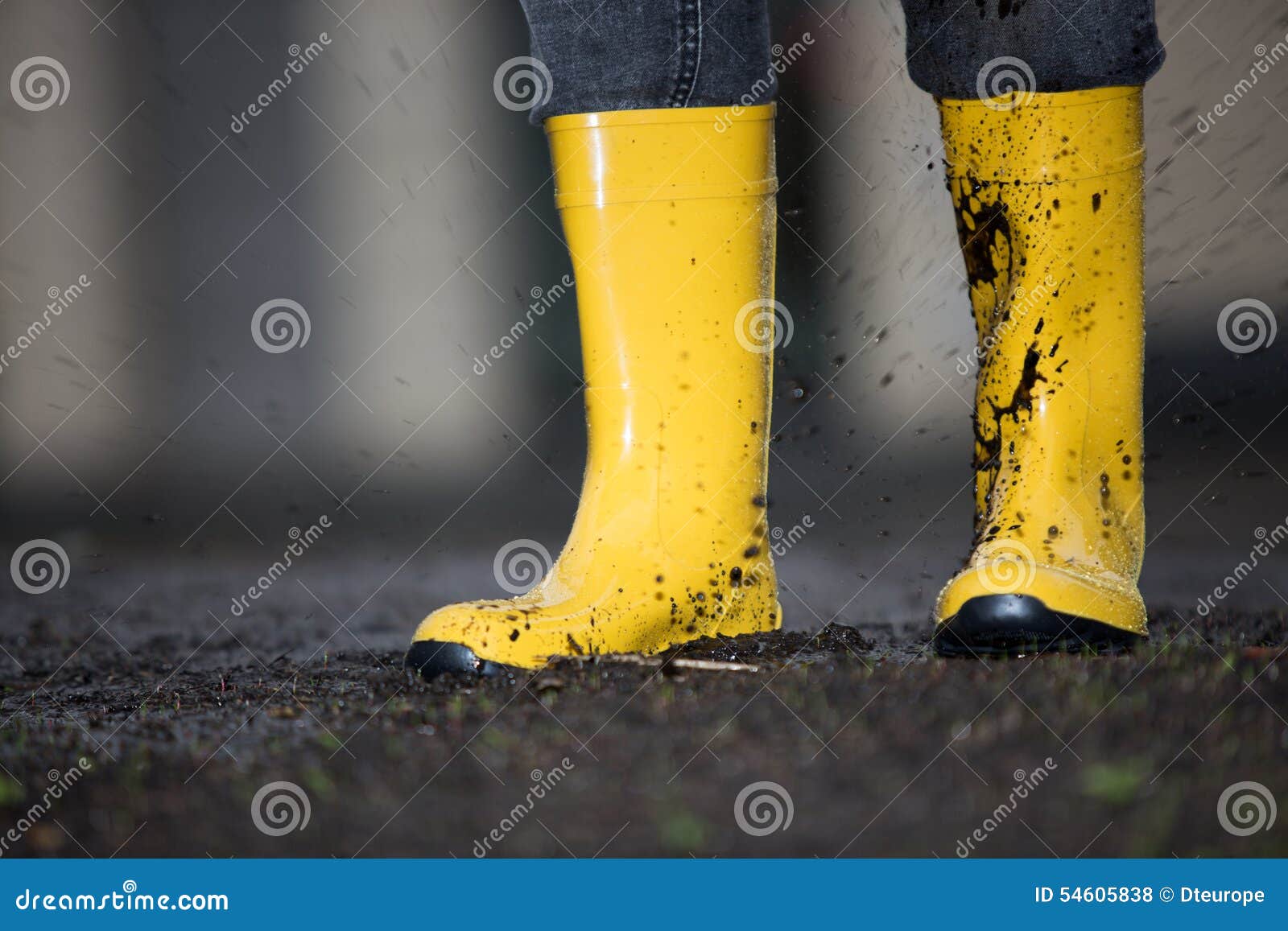 Yellow Rubber Boots in a Dirty Puddle Stock Photo - Image of coat, jump ...