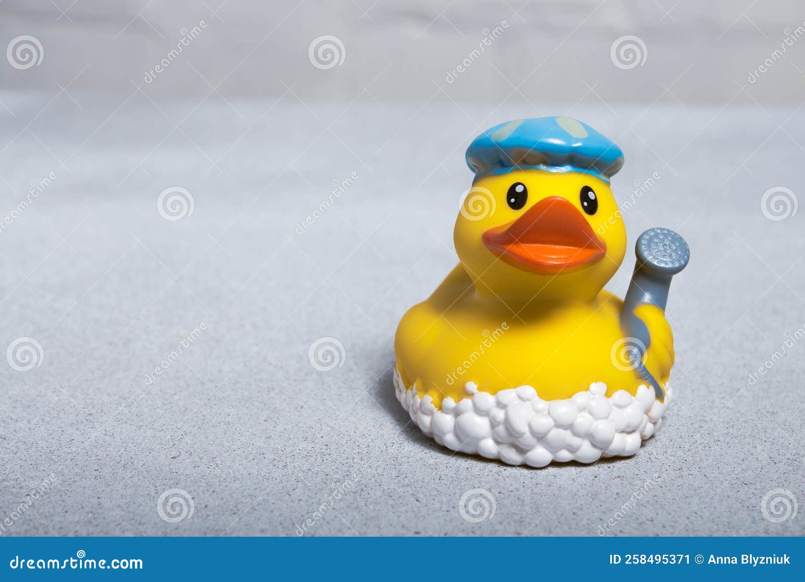 Yellow Rubber Duck for a Bath in a Bath Cap and with a Shower Head in ...
