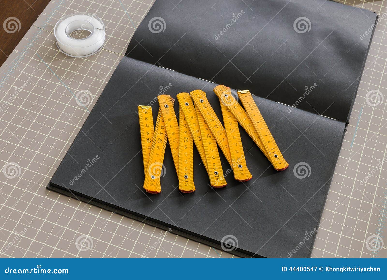Yellow ruler on black book stock image. Image of foot - 44400547