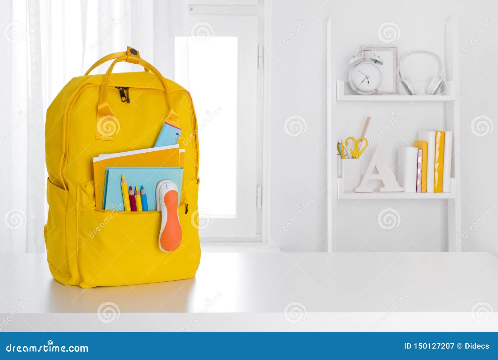 Yellow School Backpack on Table Over Children Room Interior Stock Image ...