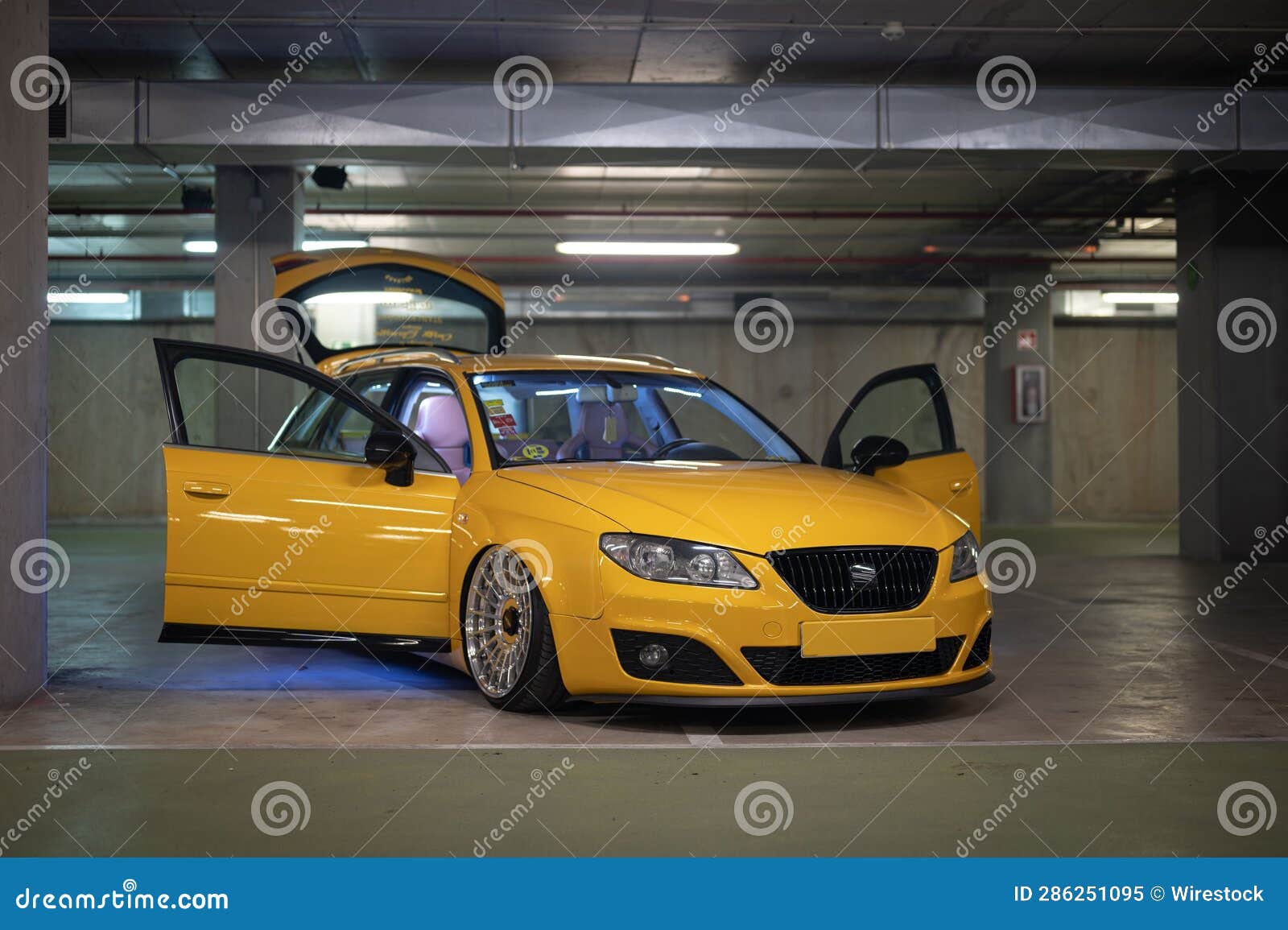 Yellow Seat Exeo ST with the Doors and Trunk Open in an Underground ...