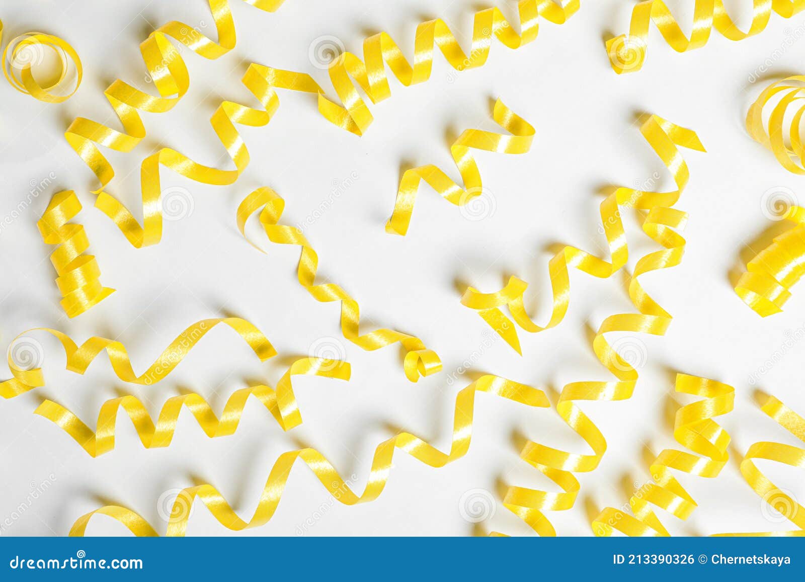 Yellow Serpentine Streamers on White Background, Top View Stock Photo ...