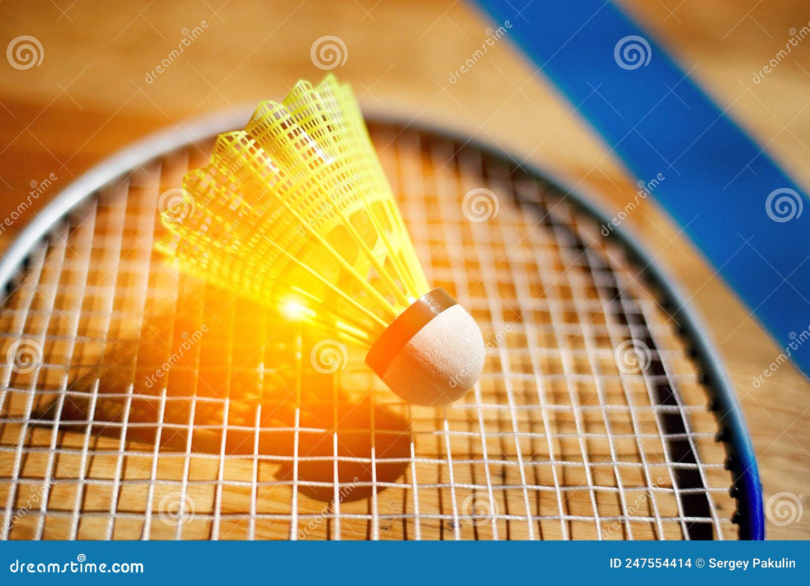 Yellow Shuttlecock for Badminton Lies on Strings of Racket. Background ...