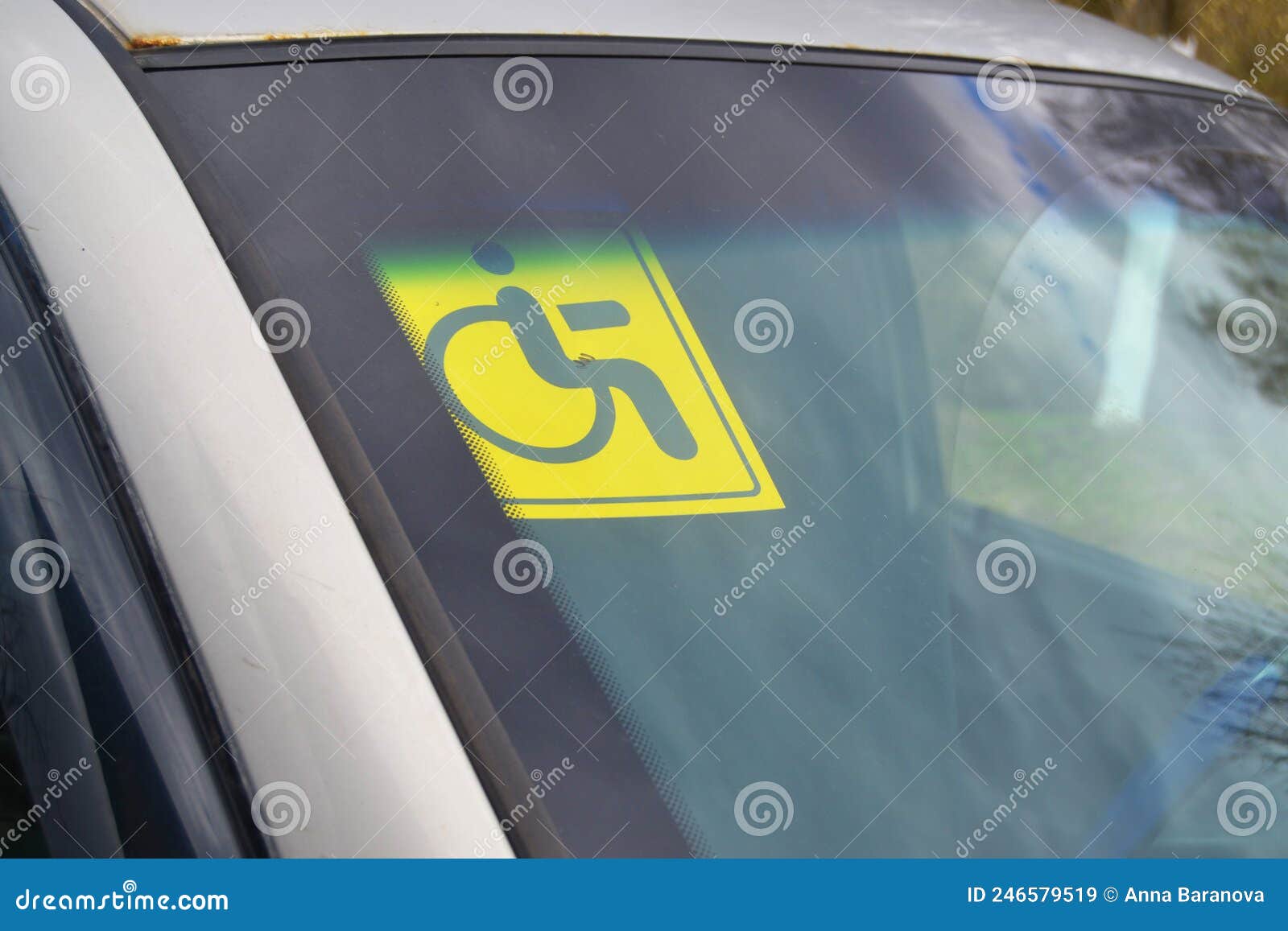 Yellow Sign of a Disabled Driver on the Windshield of the Car Stock ...