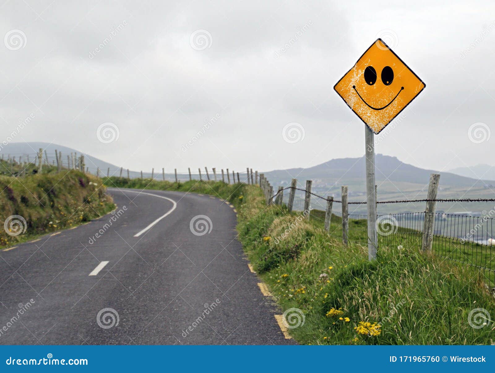 Yellow Sign with a Smiley Face on the Side of the Road Stock Photo ...