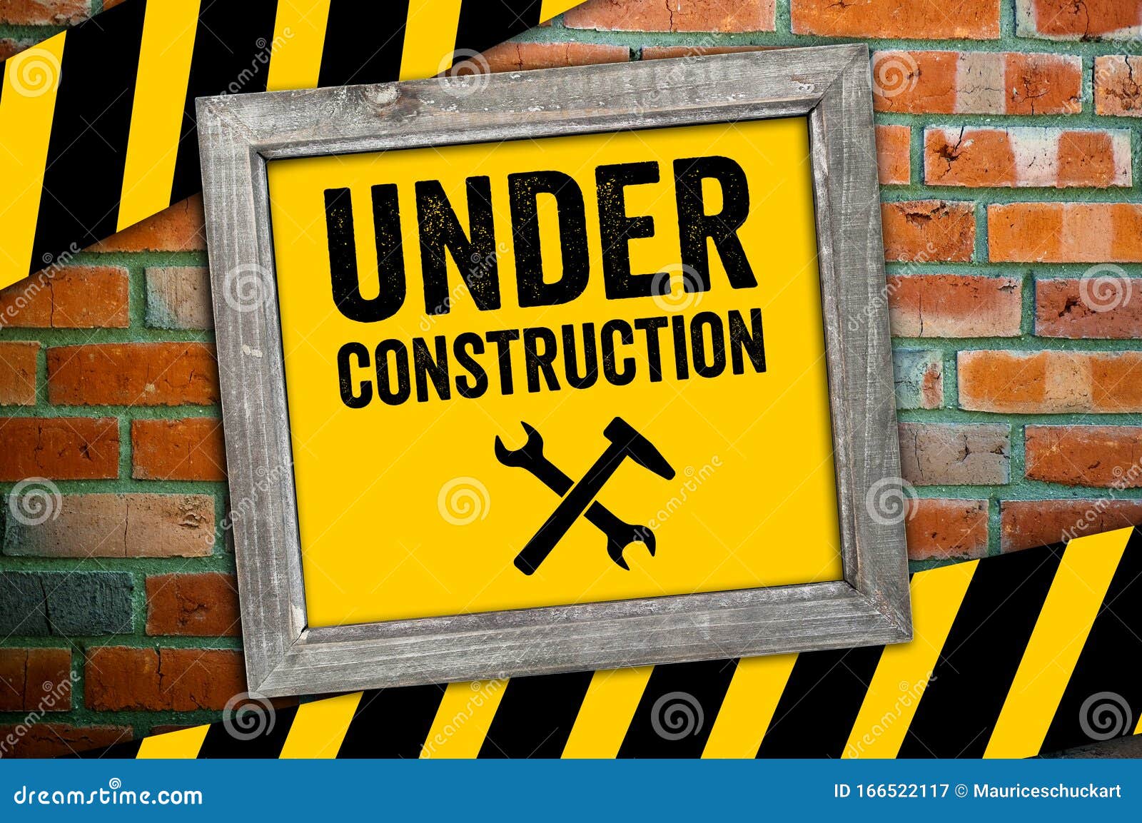 Yellow Signboard with Message Under Construction in Front of a Clinker ...