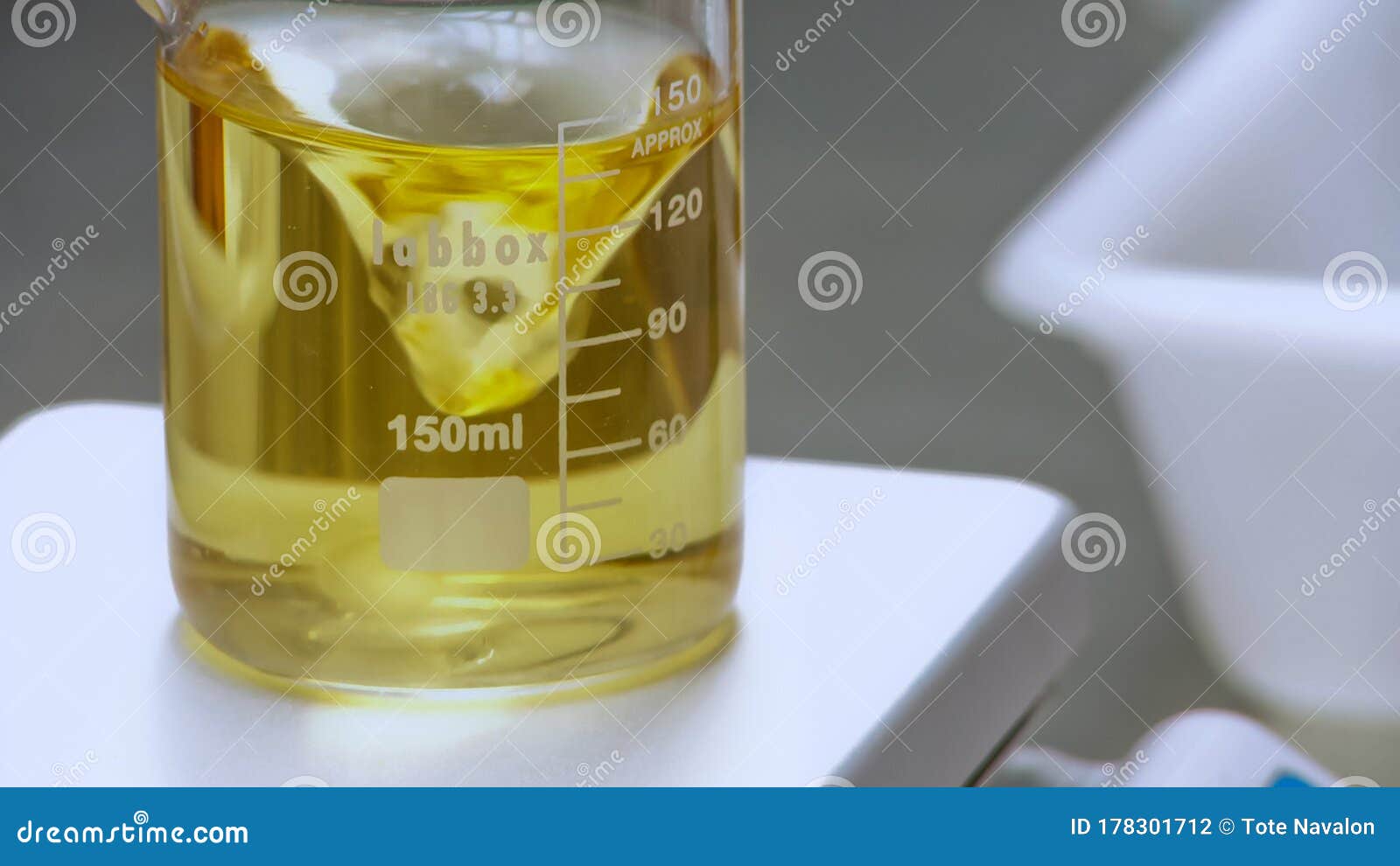 Yellow Solution in a Beaker Agitated with Magnetic Stirred in the ...