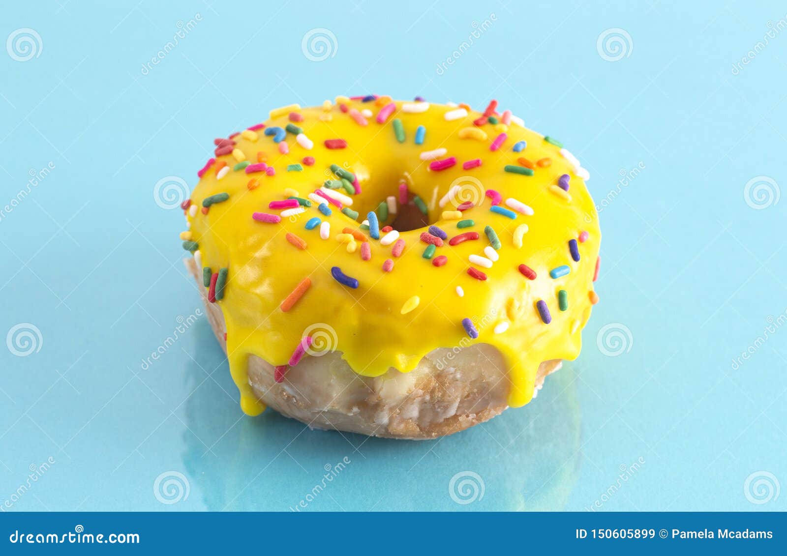 Yellow Sprinkle Donut on a Blue Background Stock Image - Image of ...