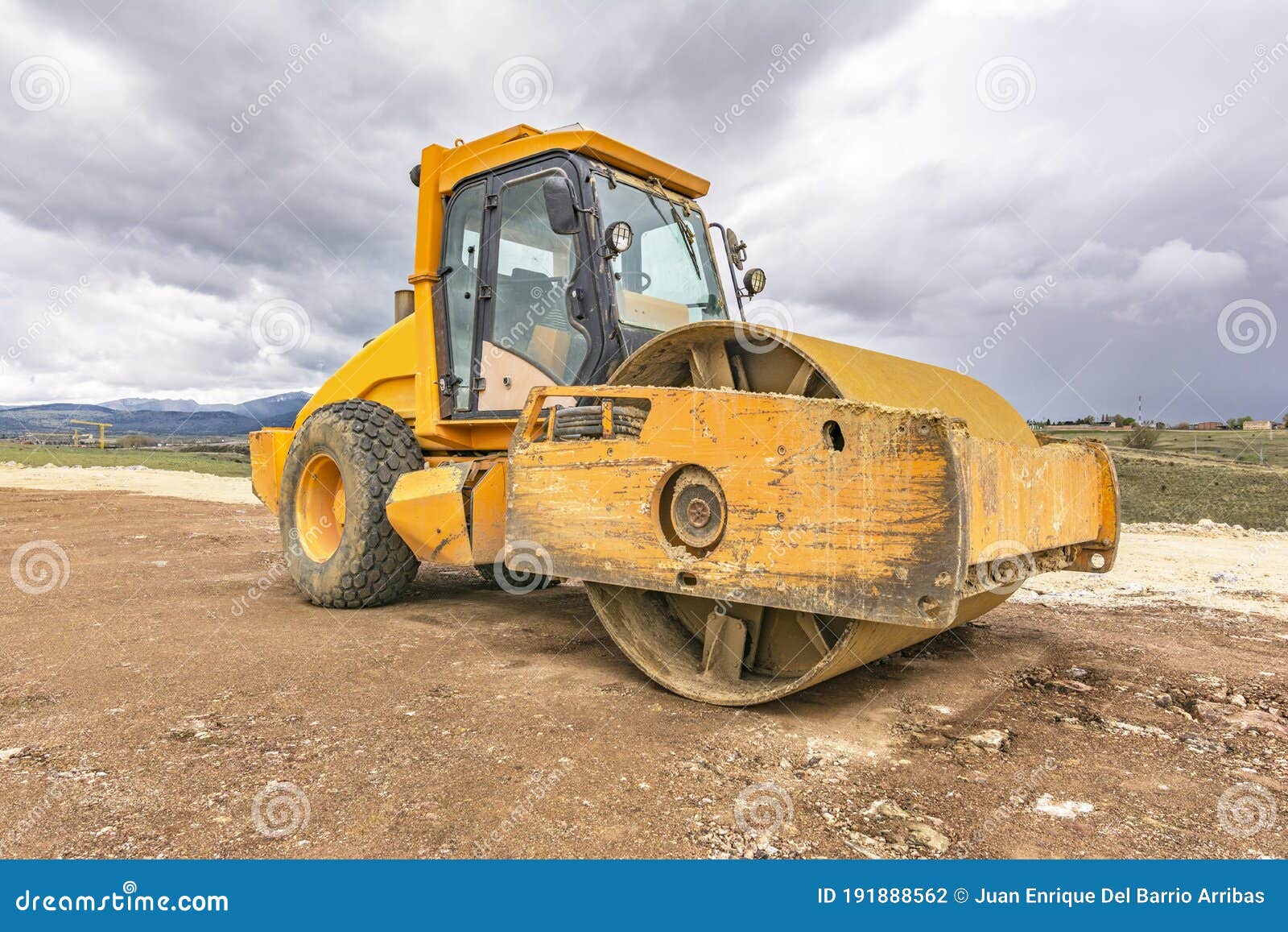 Yellow Steamroller Performing Ground Leveling Work Stock Photo - Image ...