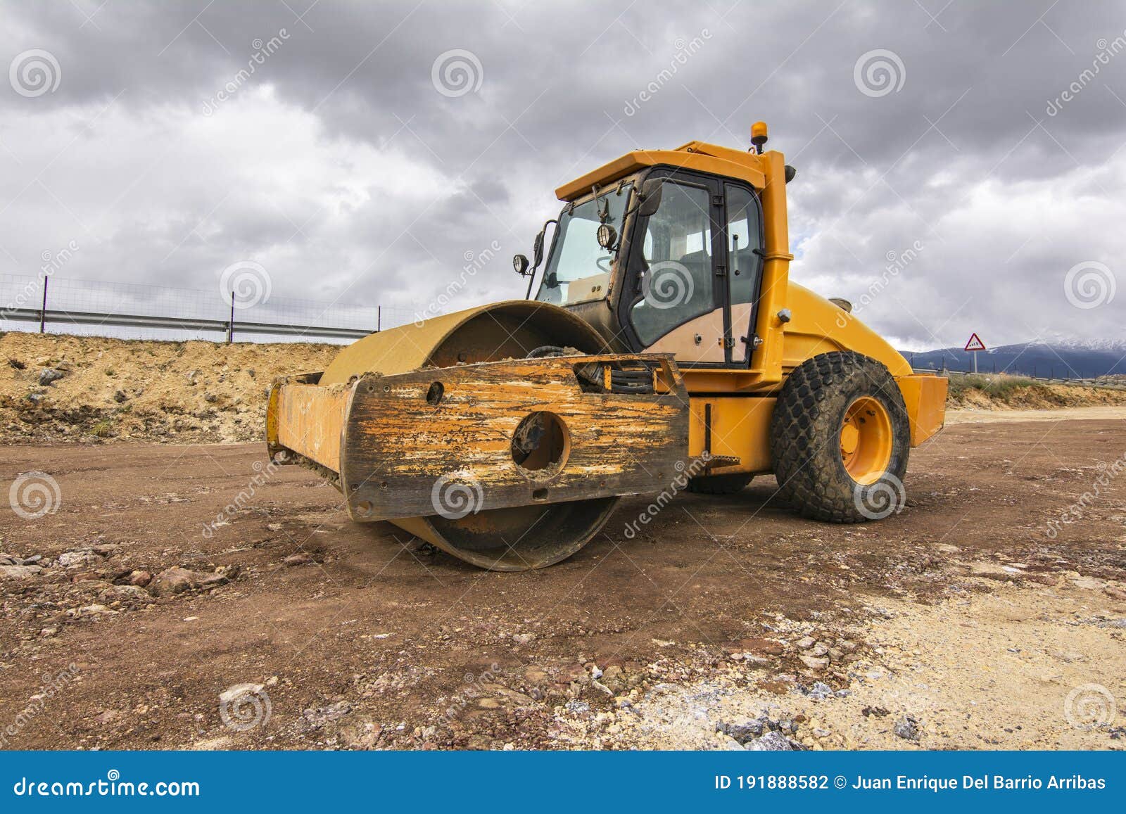 Yellow Steamroller Performing Ground Leveling Work Stock Photo - Image ...