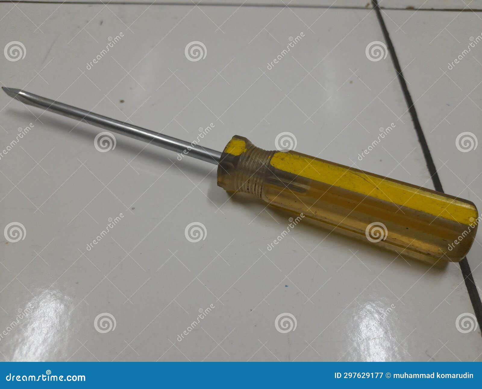 A Yellow-stemmed Iron Screwdriver Lay on the Floor of the Room Stock ...