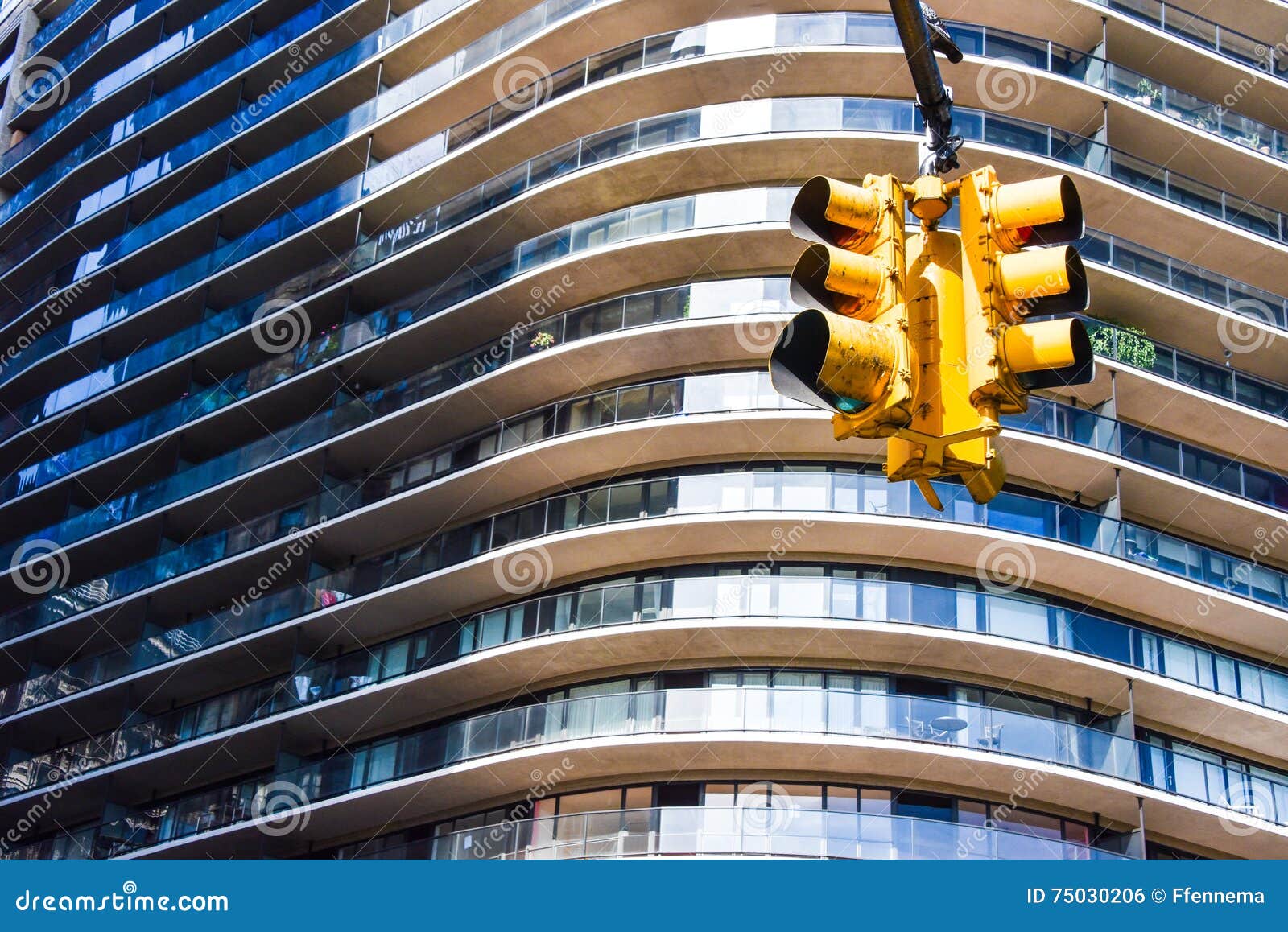 Yellow Stop Light in Front of a Large Building Stock Photo - Image of ...