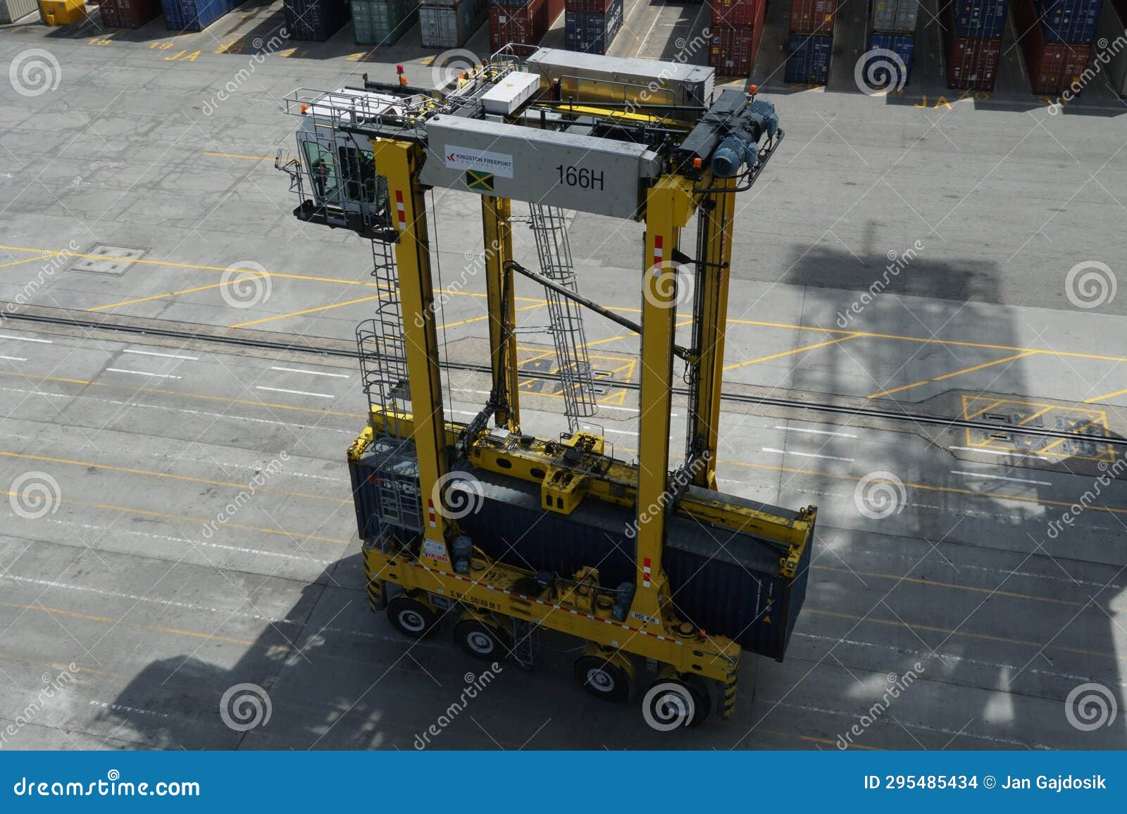 A Yellow Straddle Carrier with Loaded Blue Container in Kingston ...