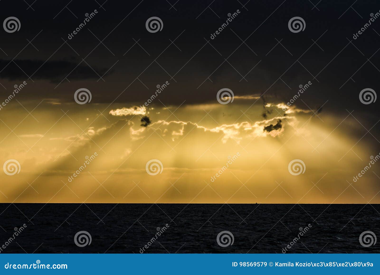 Yellow Sunset with Piercing Light Rays through the Clouds. Stock Image ...