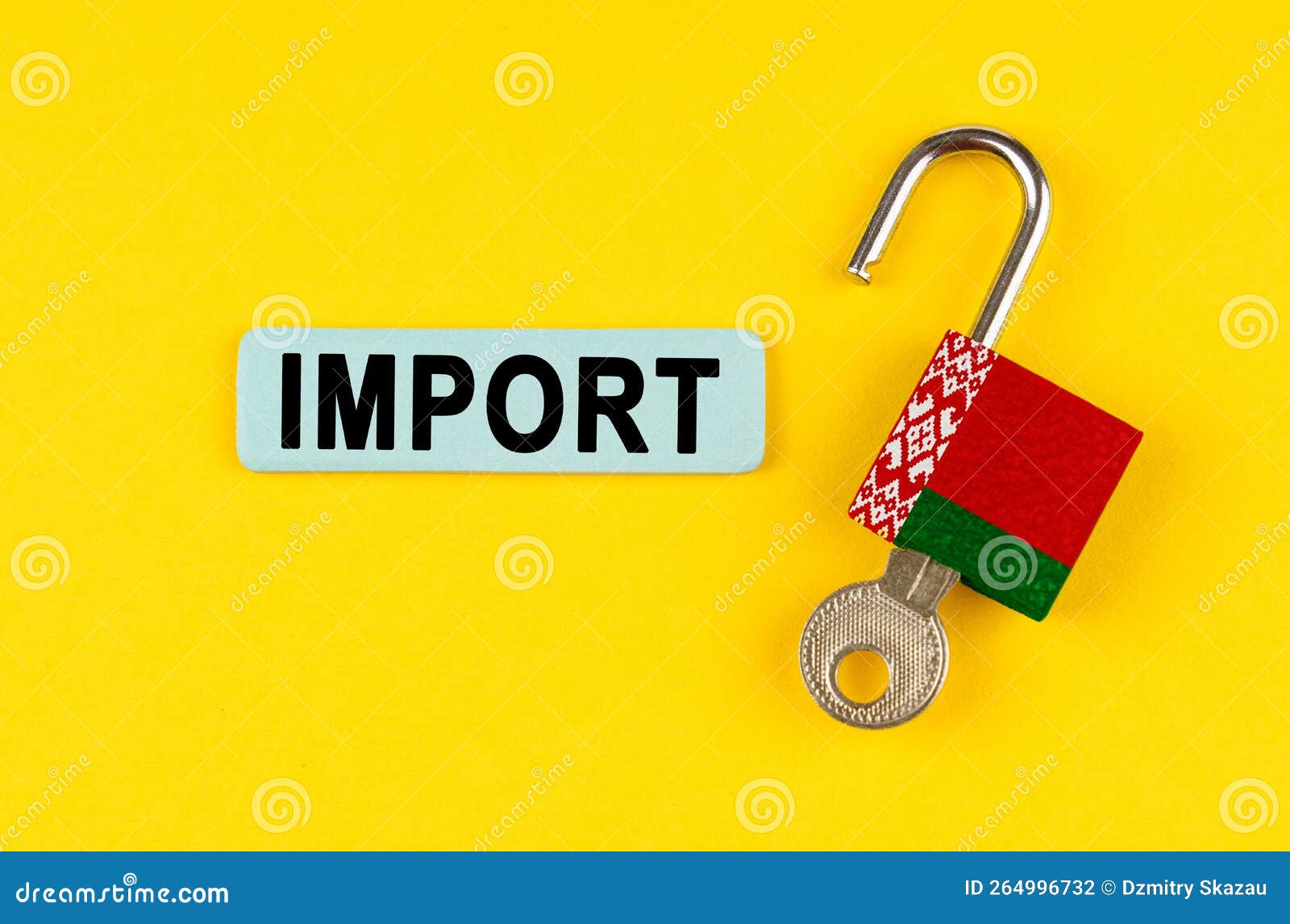 On the Yellow Surface is an Open Lock with a Key and a Sticker with the ...