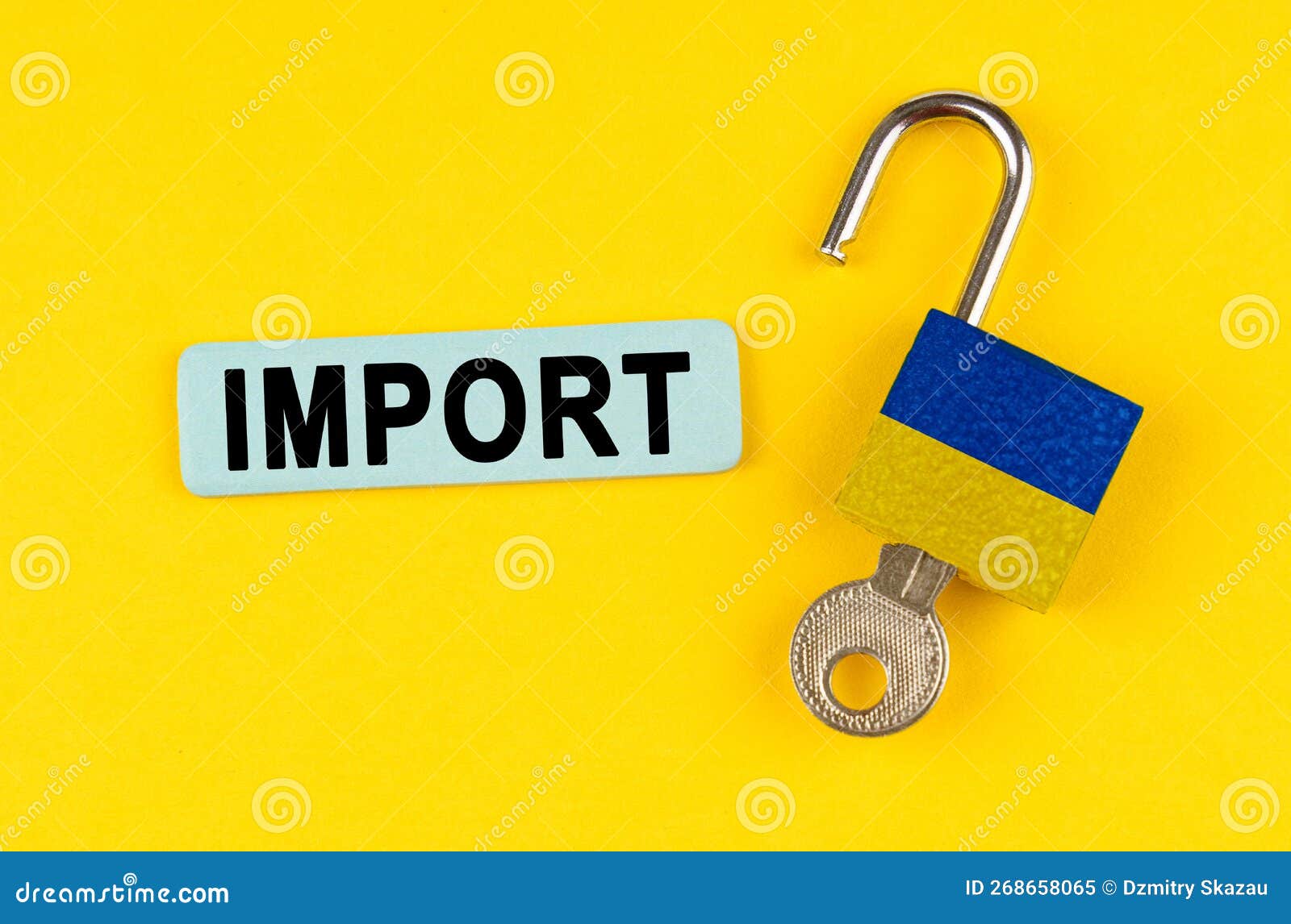 On the Yellow Surface is an Open Lock with a Key and a Sticker with the ...