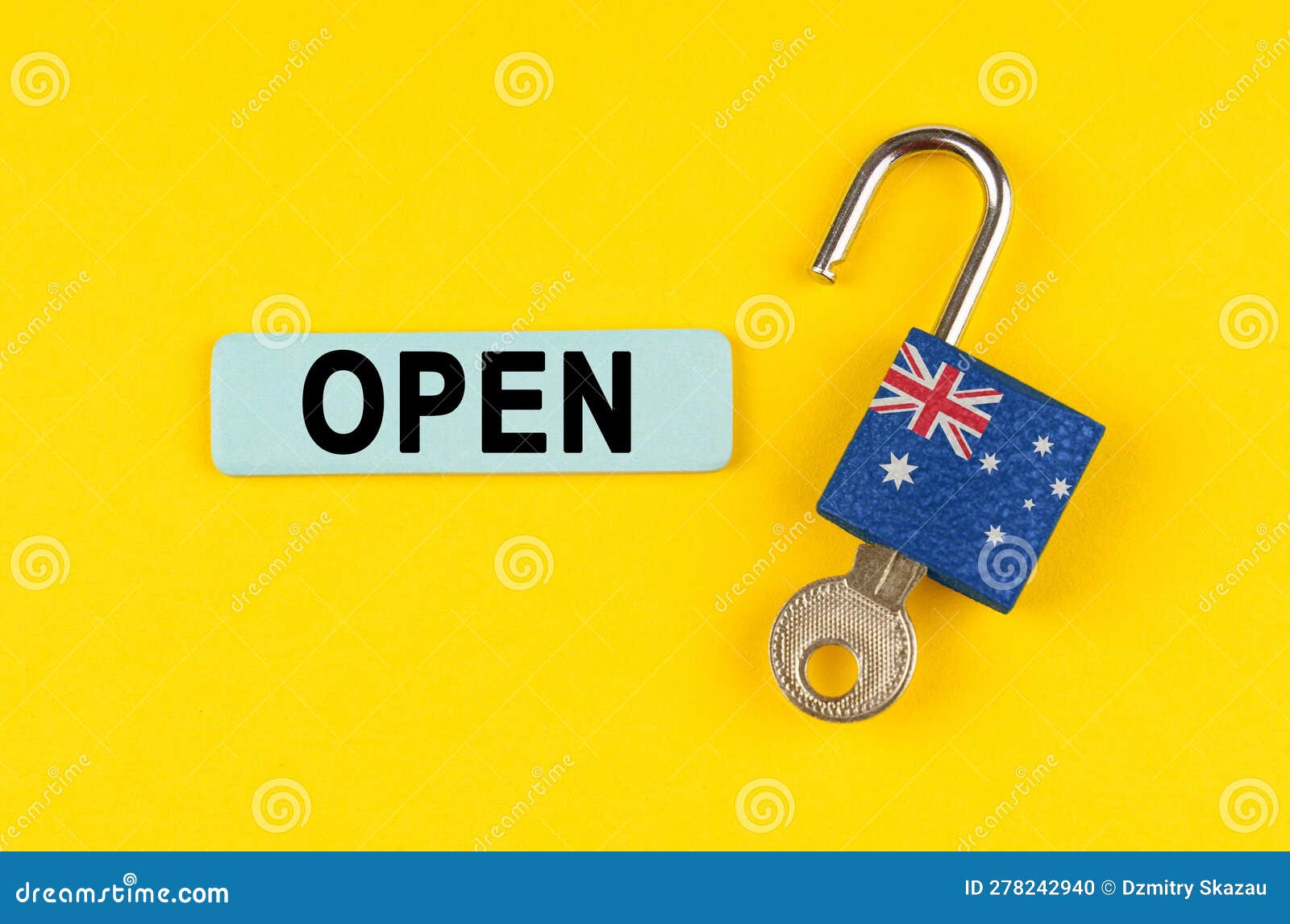 On the Yellow Surface is an Open Lock with a Key and a Sticker with the ...