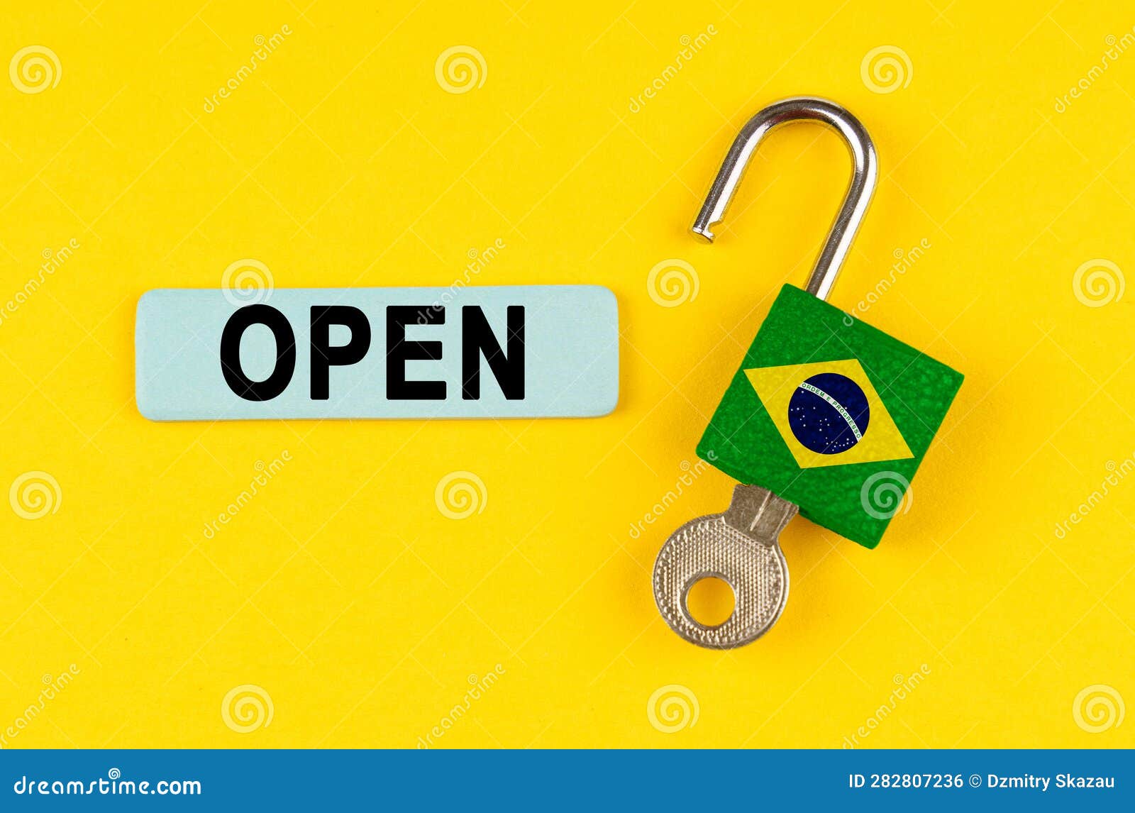 On the Yellow Surface is an Open Lock with a Key and a Sticker with the ...