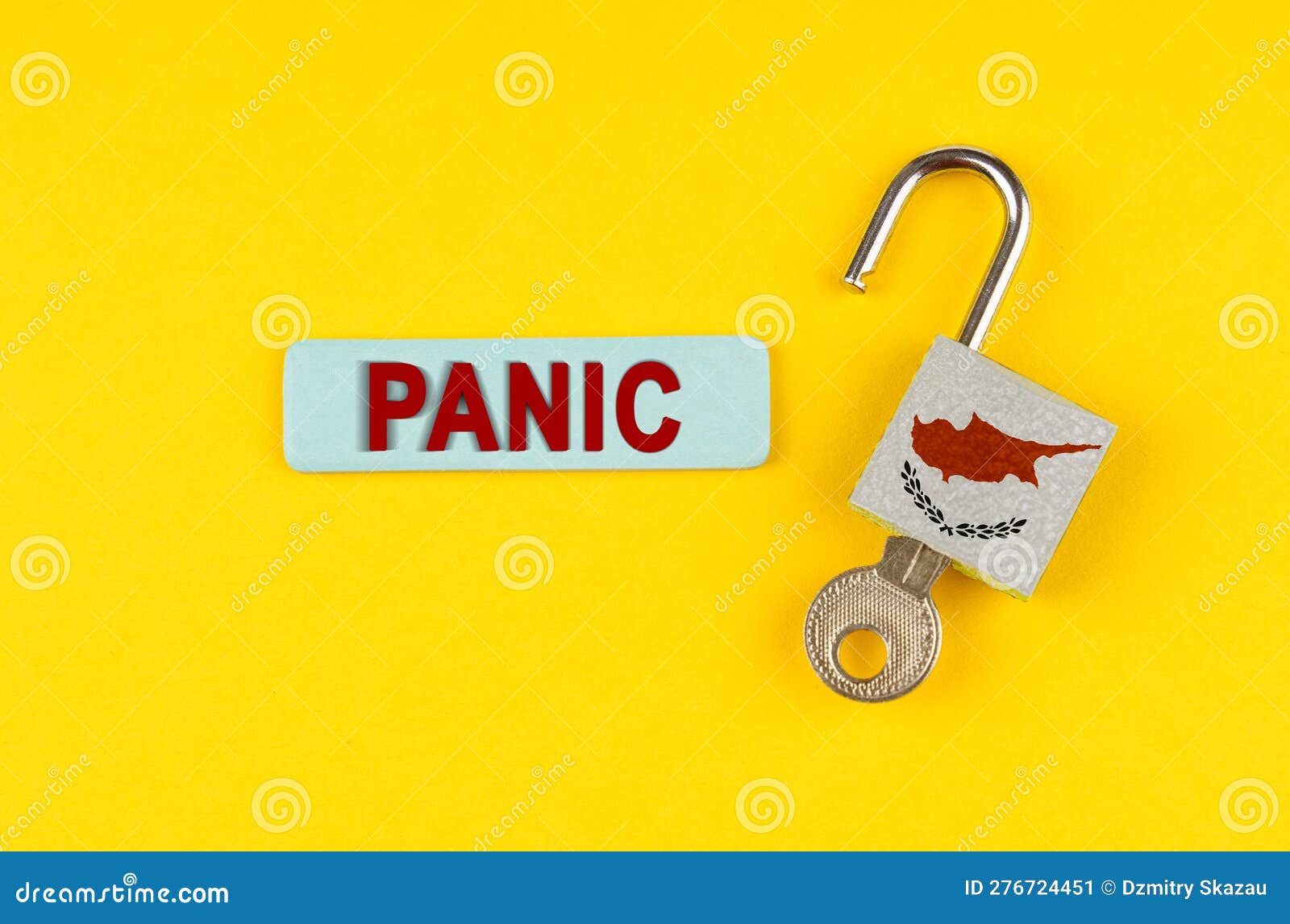 On the Yellow Surface is an Open Lock with a Key and a Sticker with the ...