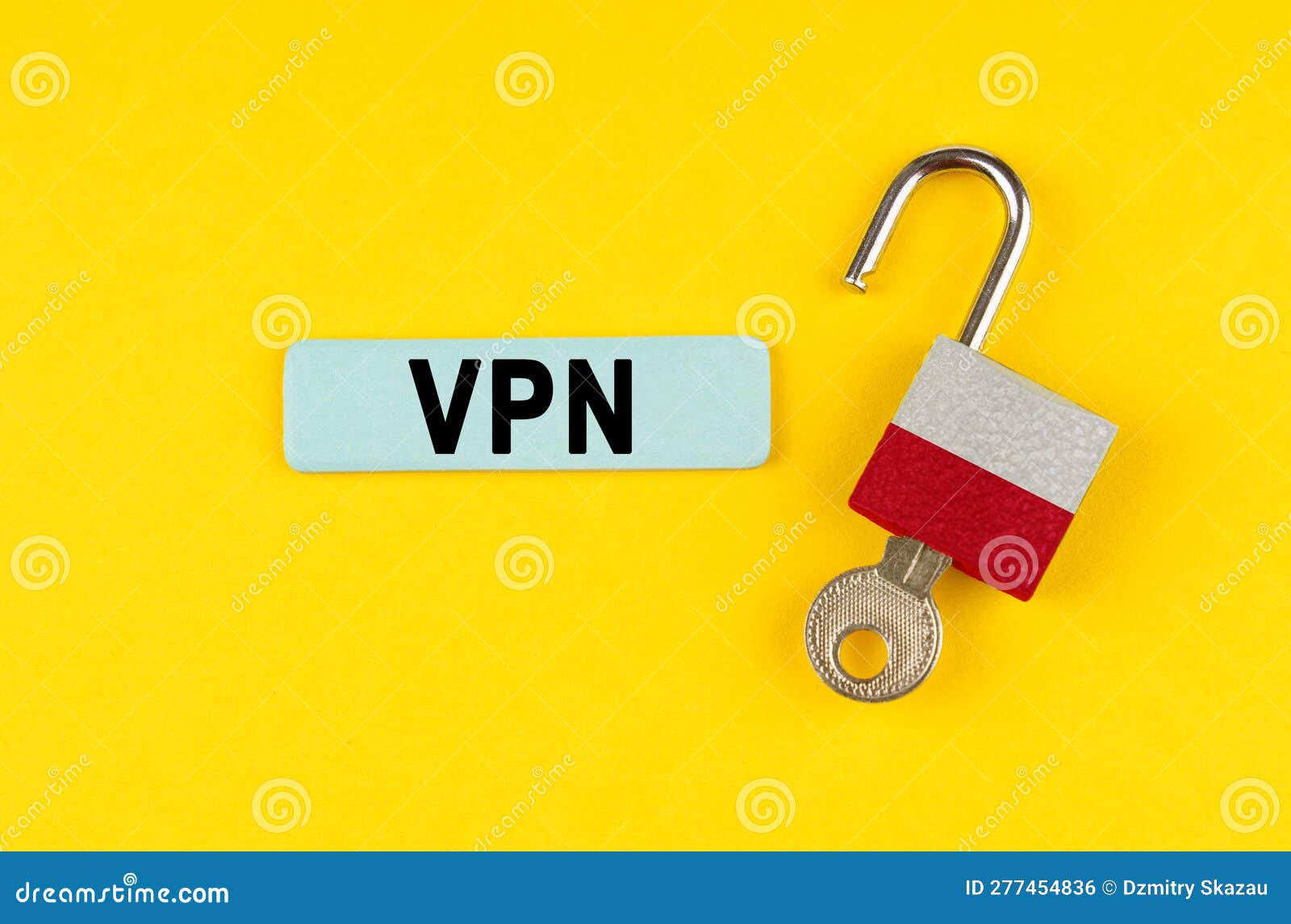 On the Yellow Surface is an Open Lock with a Key and a Sticker with the ...