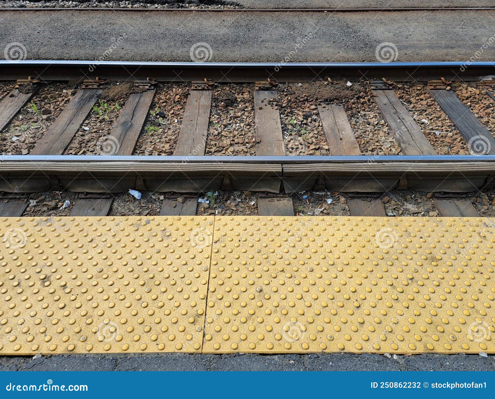 Yellow Tactile Bumps on Cement Next To Train Track Stock Photo - Image ...