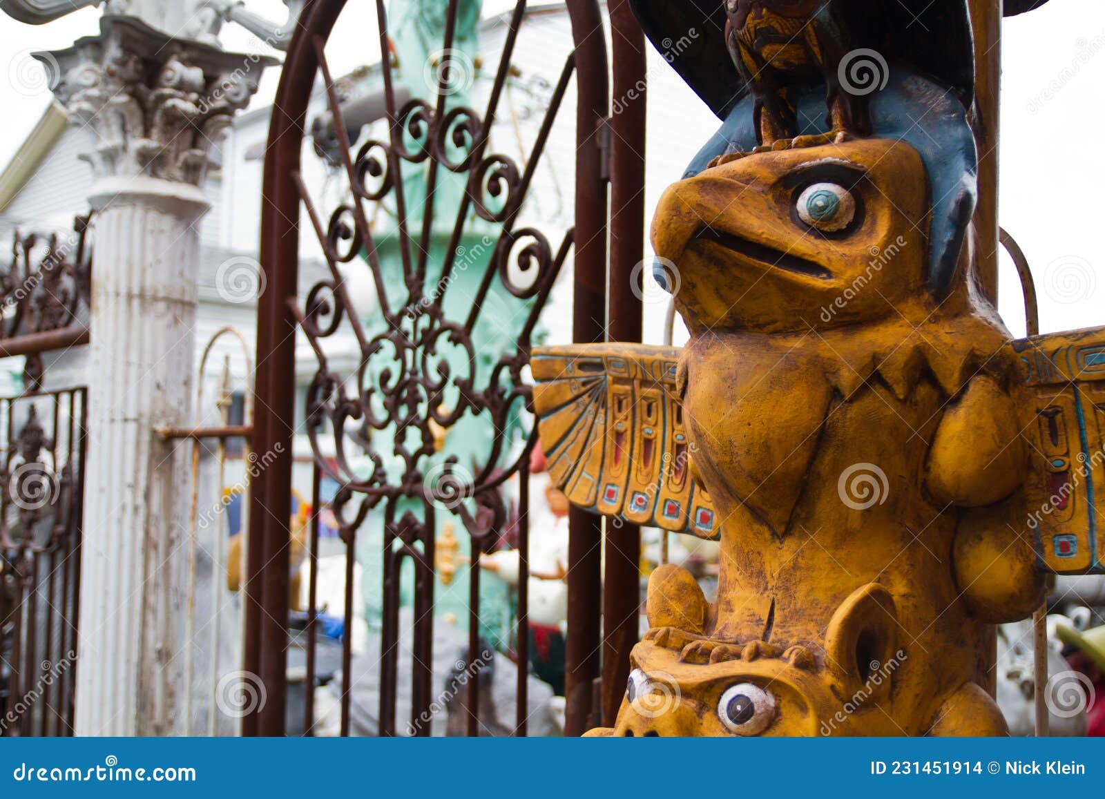 Yellow Totem Pole Eagle Outside a Wrought Iron Gate Stock Photo - Image ...