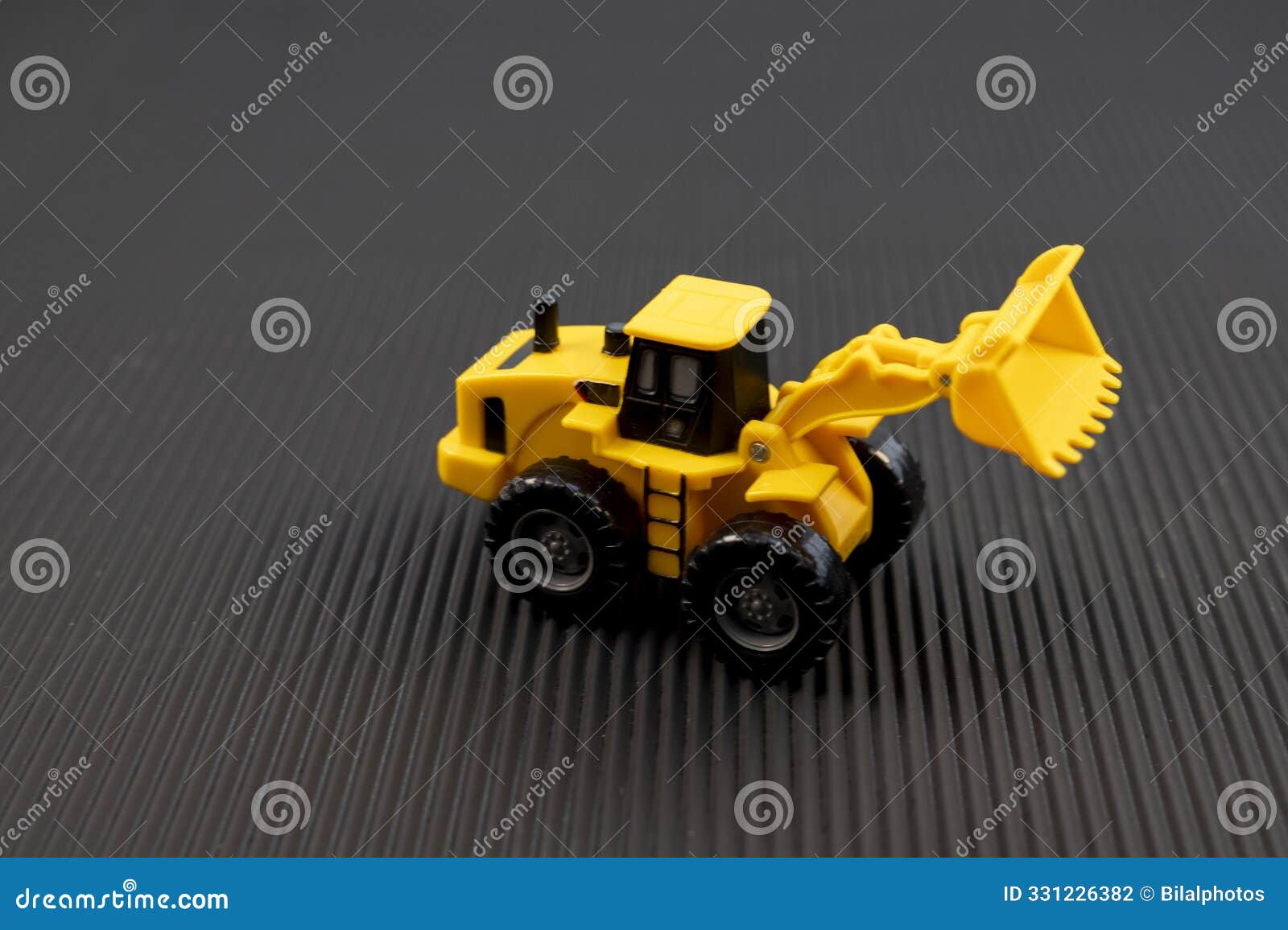 Yellow Toy Loader on Black Textured Background. Heavy Machinery Concept ...