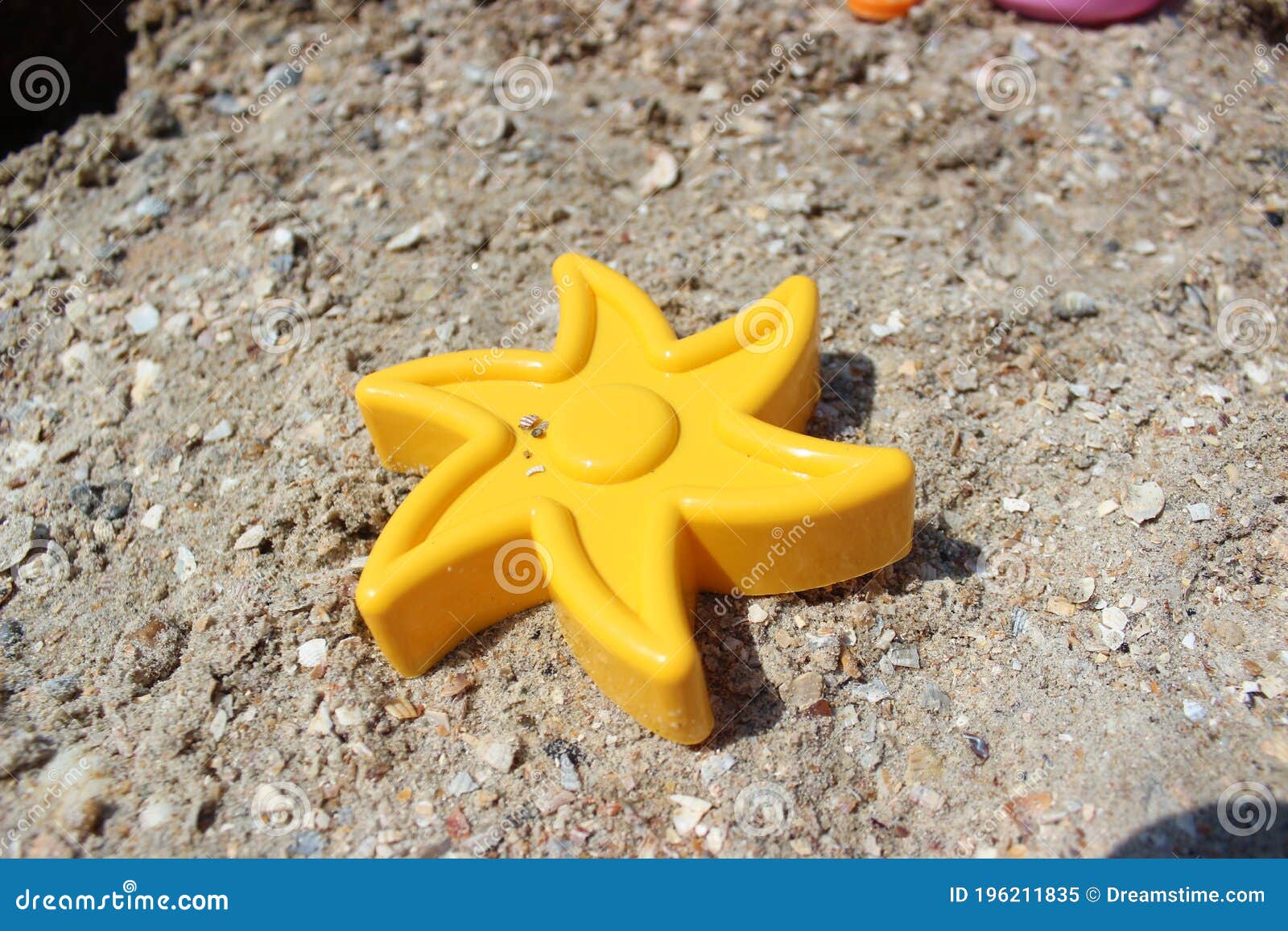Yellow Toy Star on the Sandy Beach Stock Image - Image of coast, sandy ...