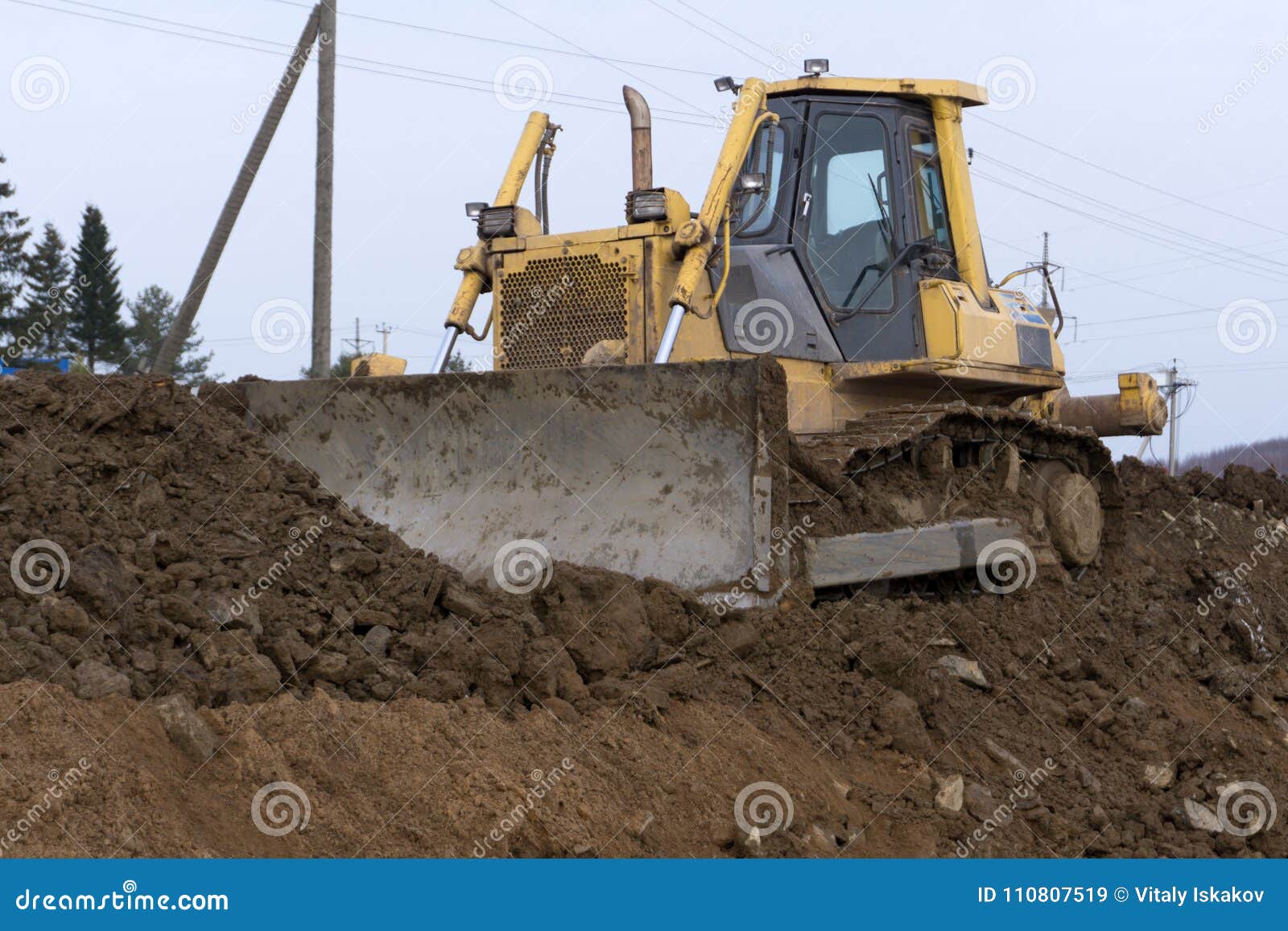 The Yellow Tractor with Attached Grederom Makes Ground Leveling. Work ...