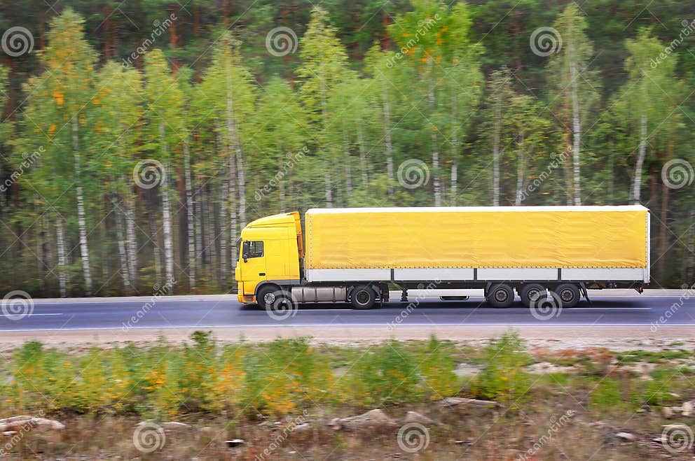 Yellow Trailer Goes on Highway Stock Photo - Image of trailer, nature ...