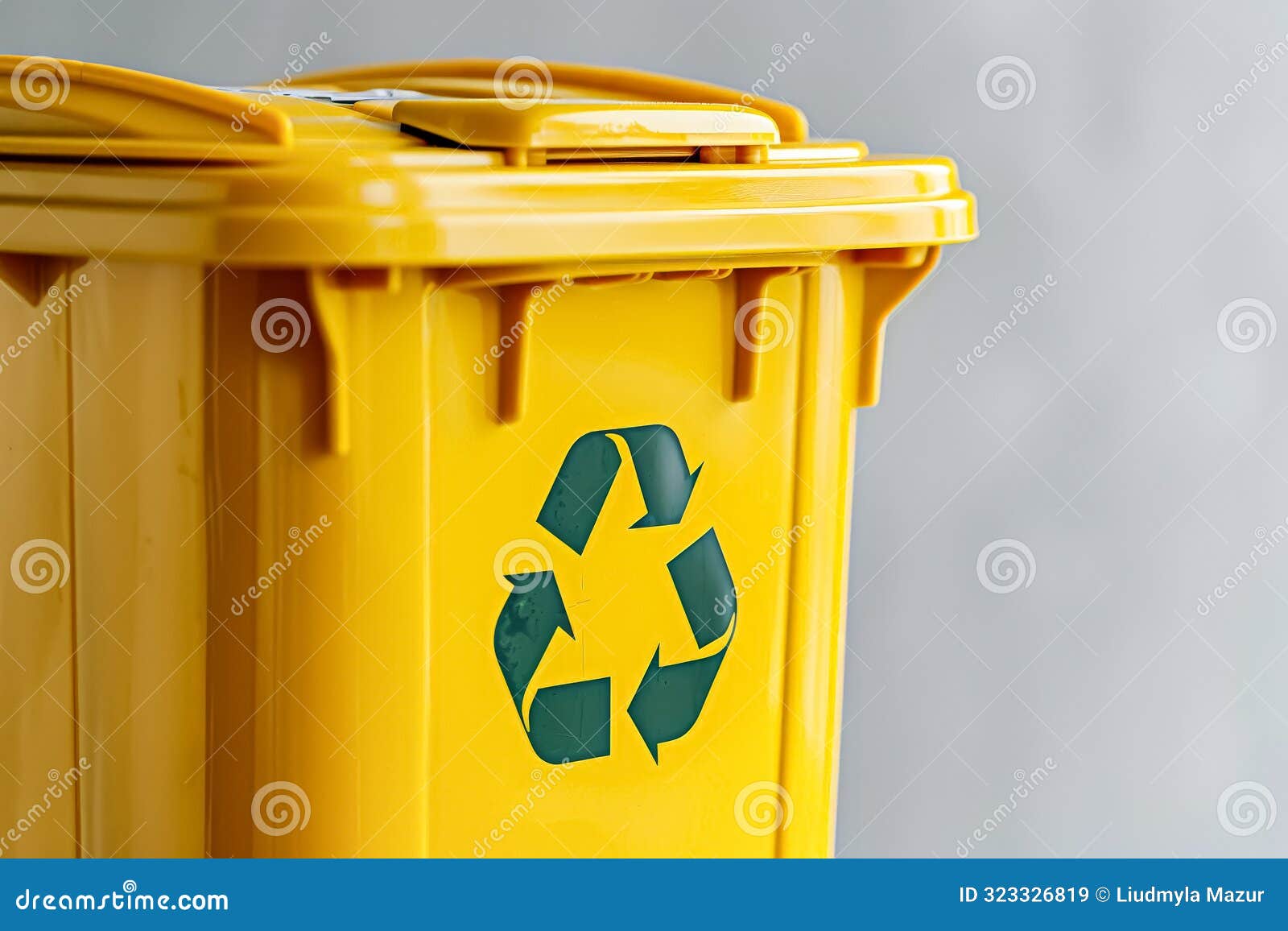 A Yellow Trash Can with a Green Recycling Symbol on it Stock Image ...