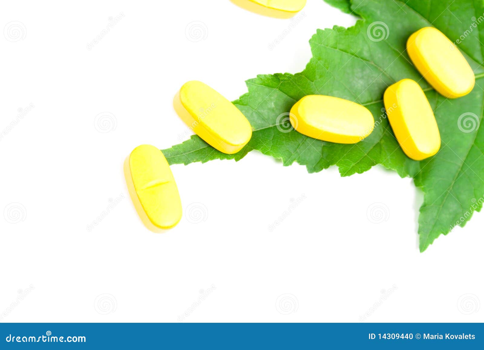 Yellow Vitamin Pills Over Green Leaf Stock Photo - Image of capsule ...