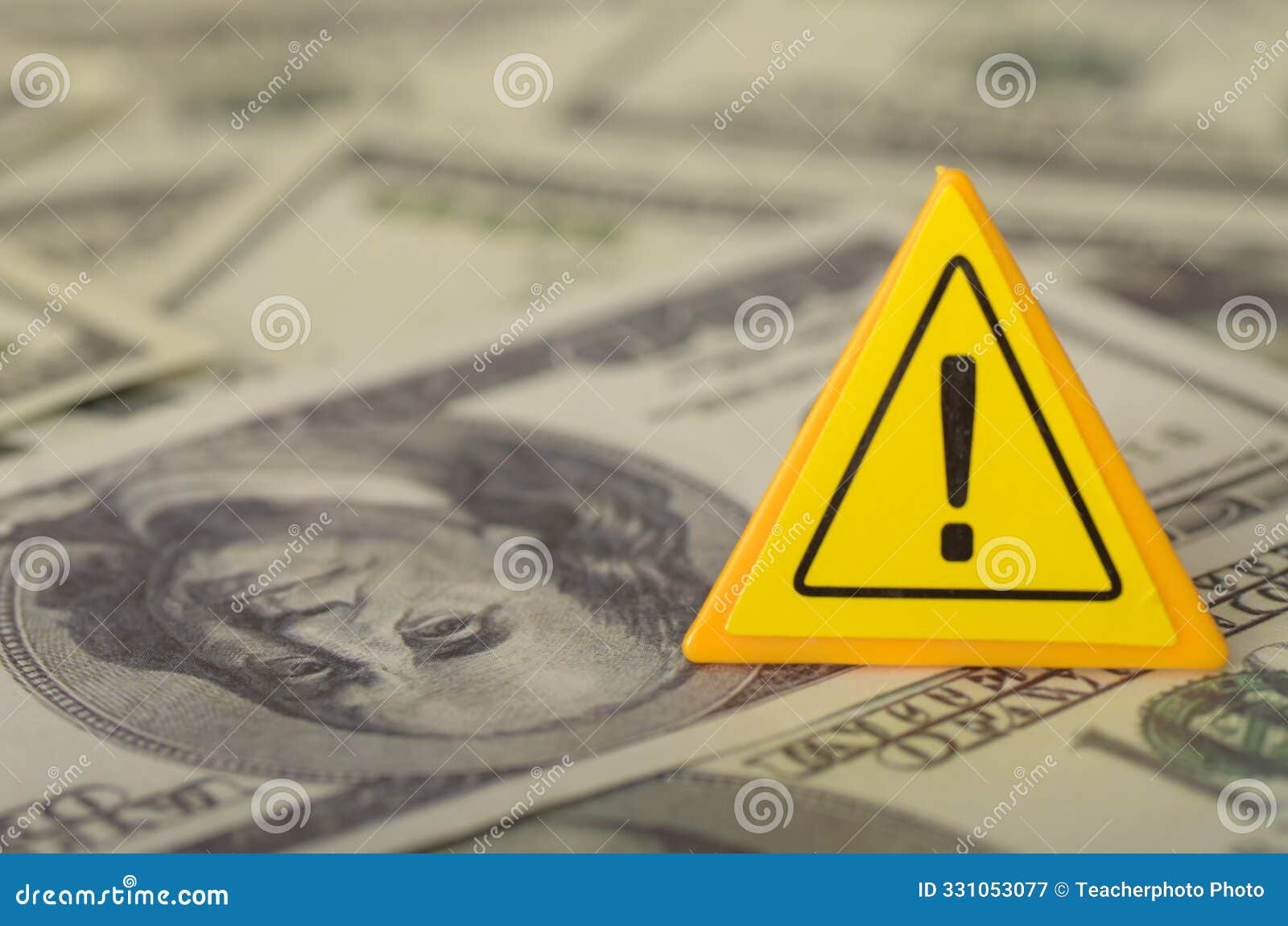 The Yellow Warning Sign Superimposed on US Dollar Bills Warns of ...