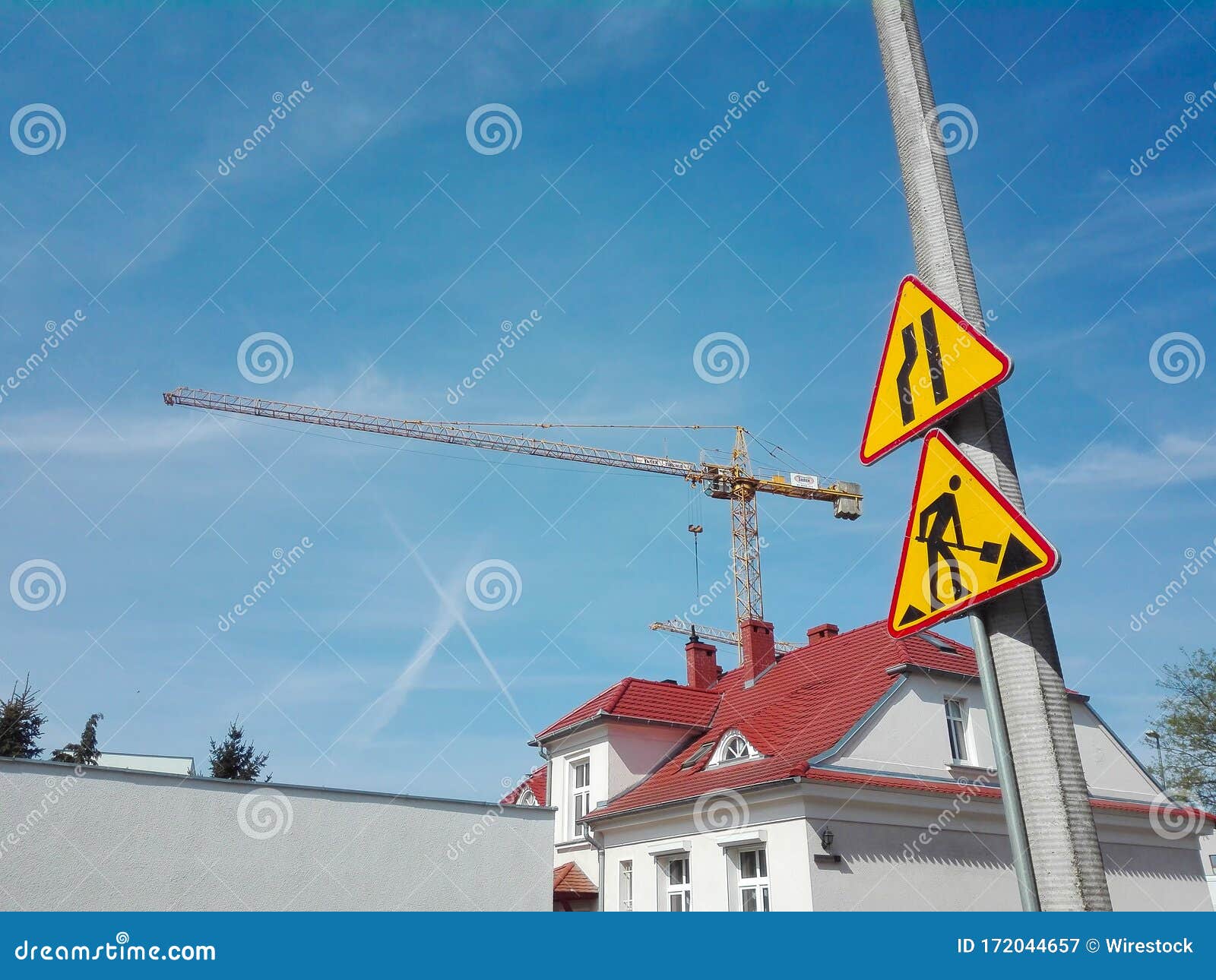 Yellow Warning Signs about Construction and Traffic in Front of White ...